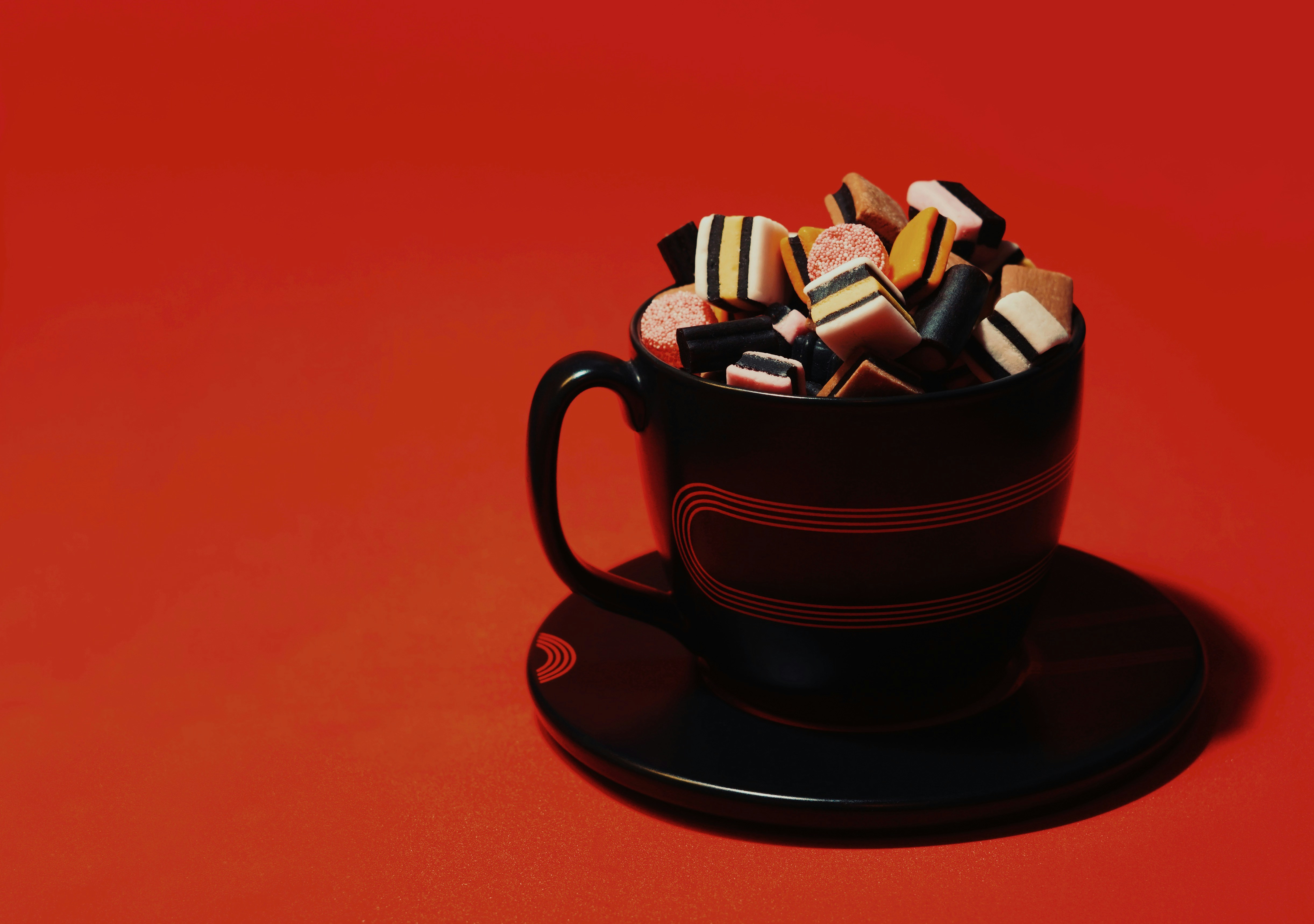 a cup of candy sitting on top of a saucer