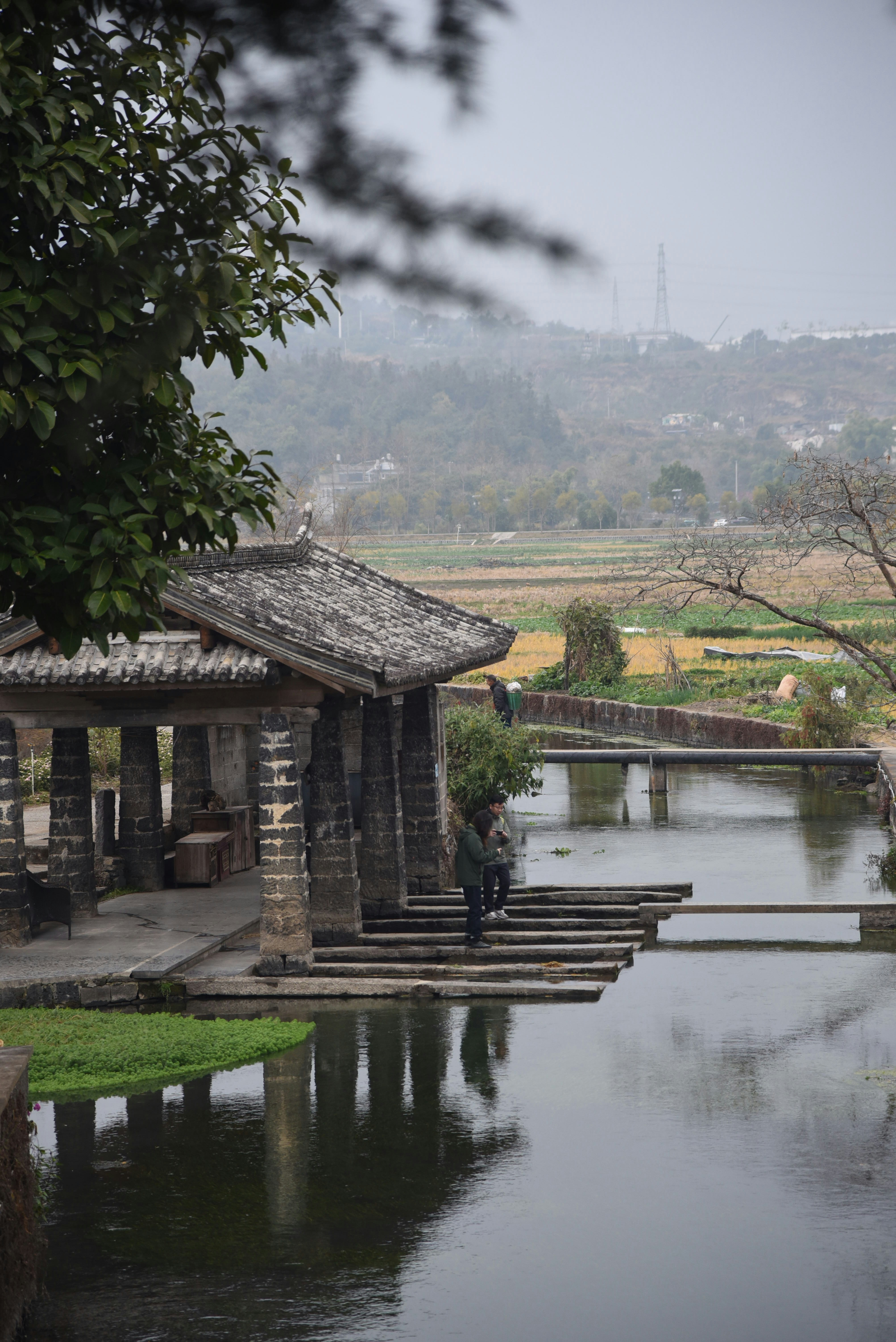Stone-porch Reverie: A Canal Pavilion Framed by Reflections