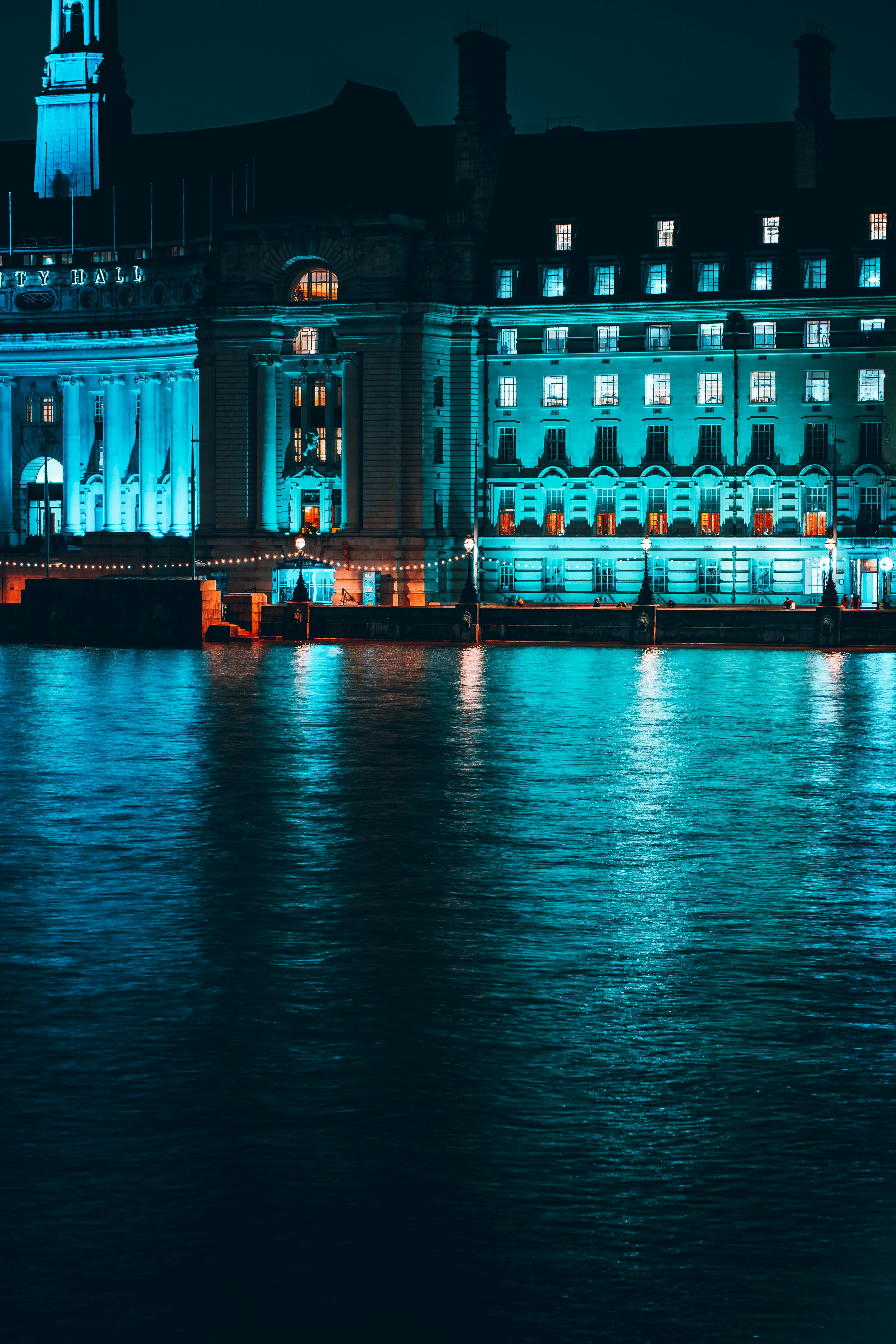 Nighttime Blue-Glow Facade Along the River