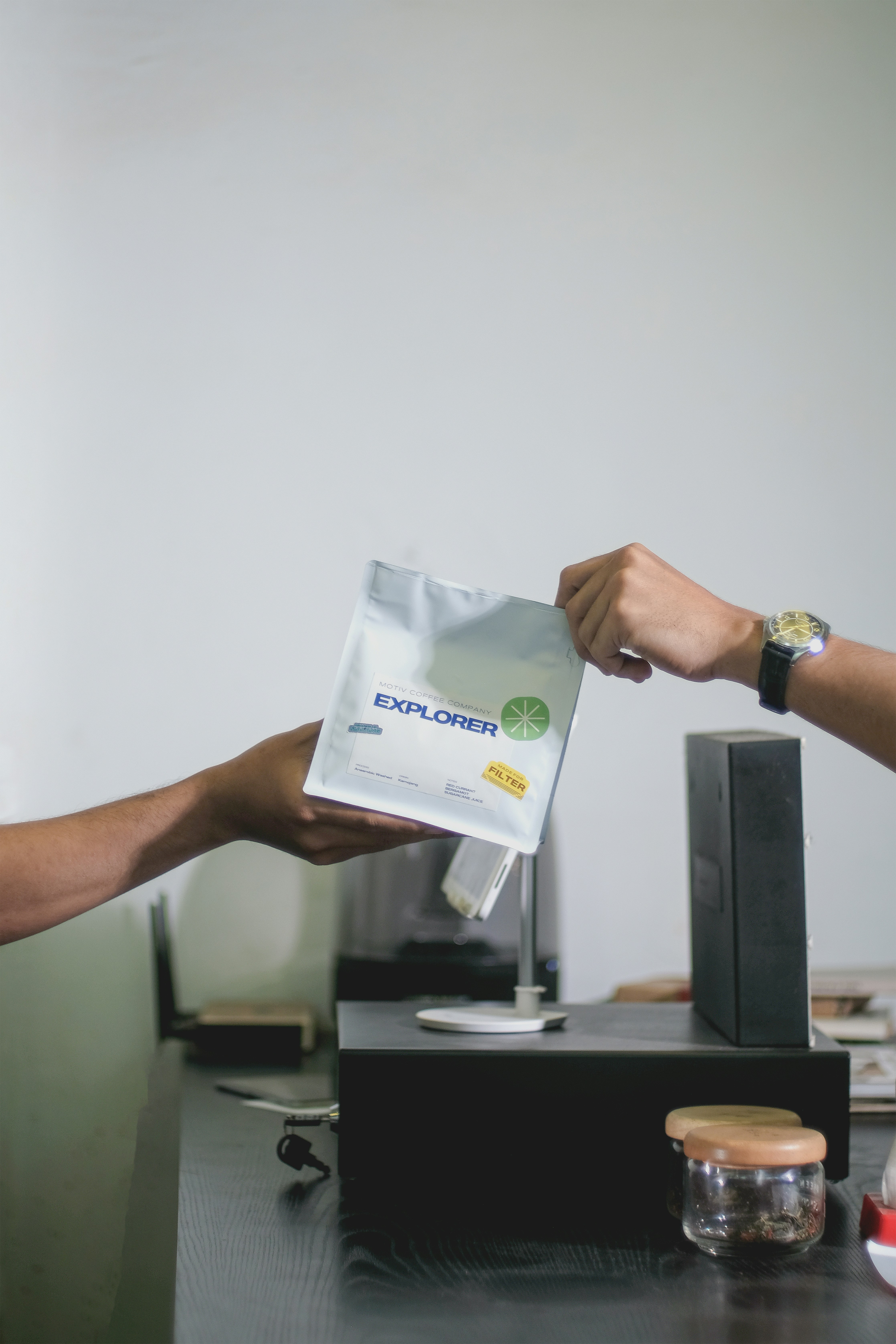 A person handing another person something out of a bag photo – Free ...