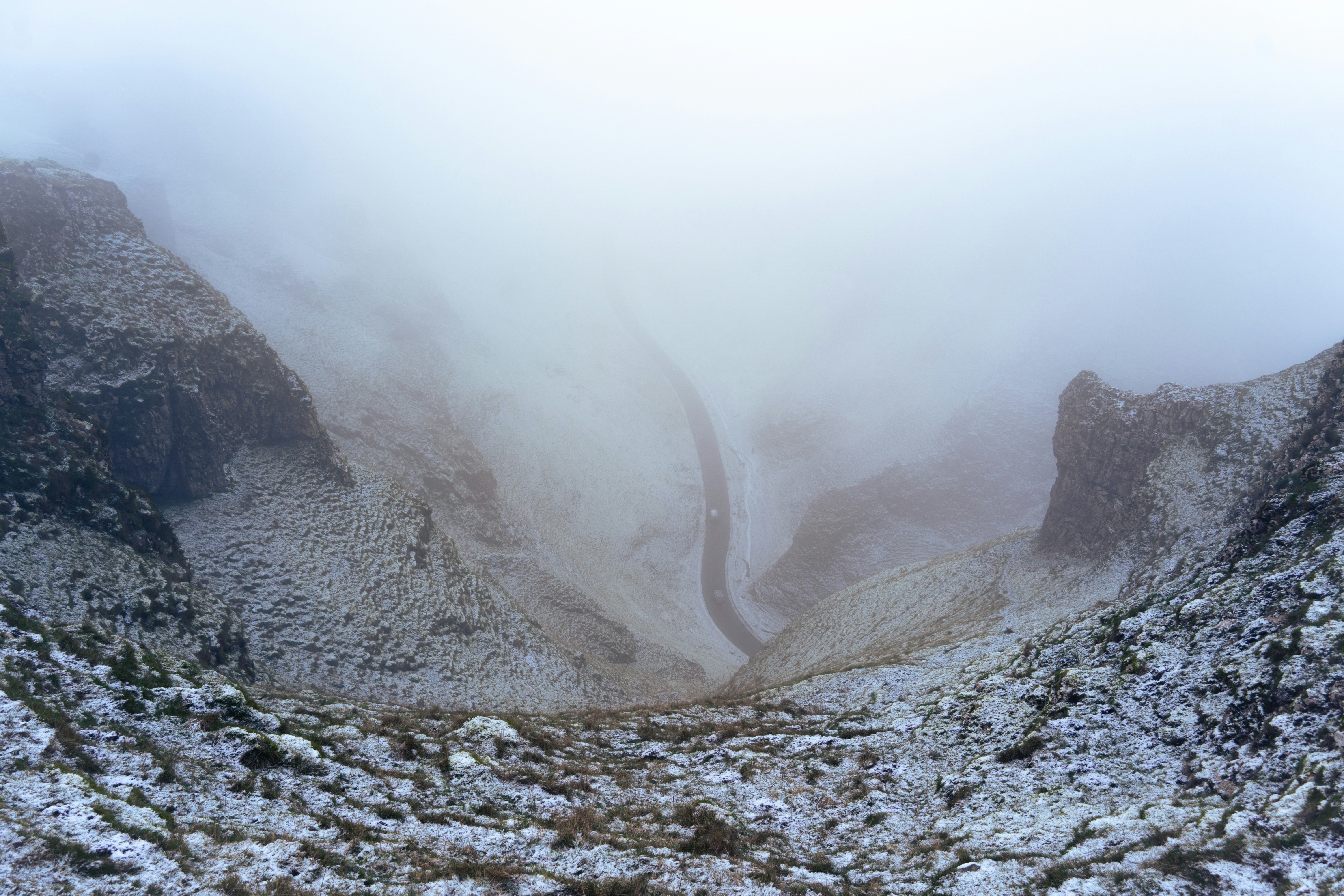 A view of a snowy mountain with a road going through it photo – Free ...