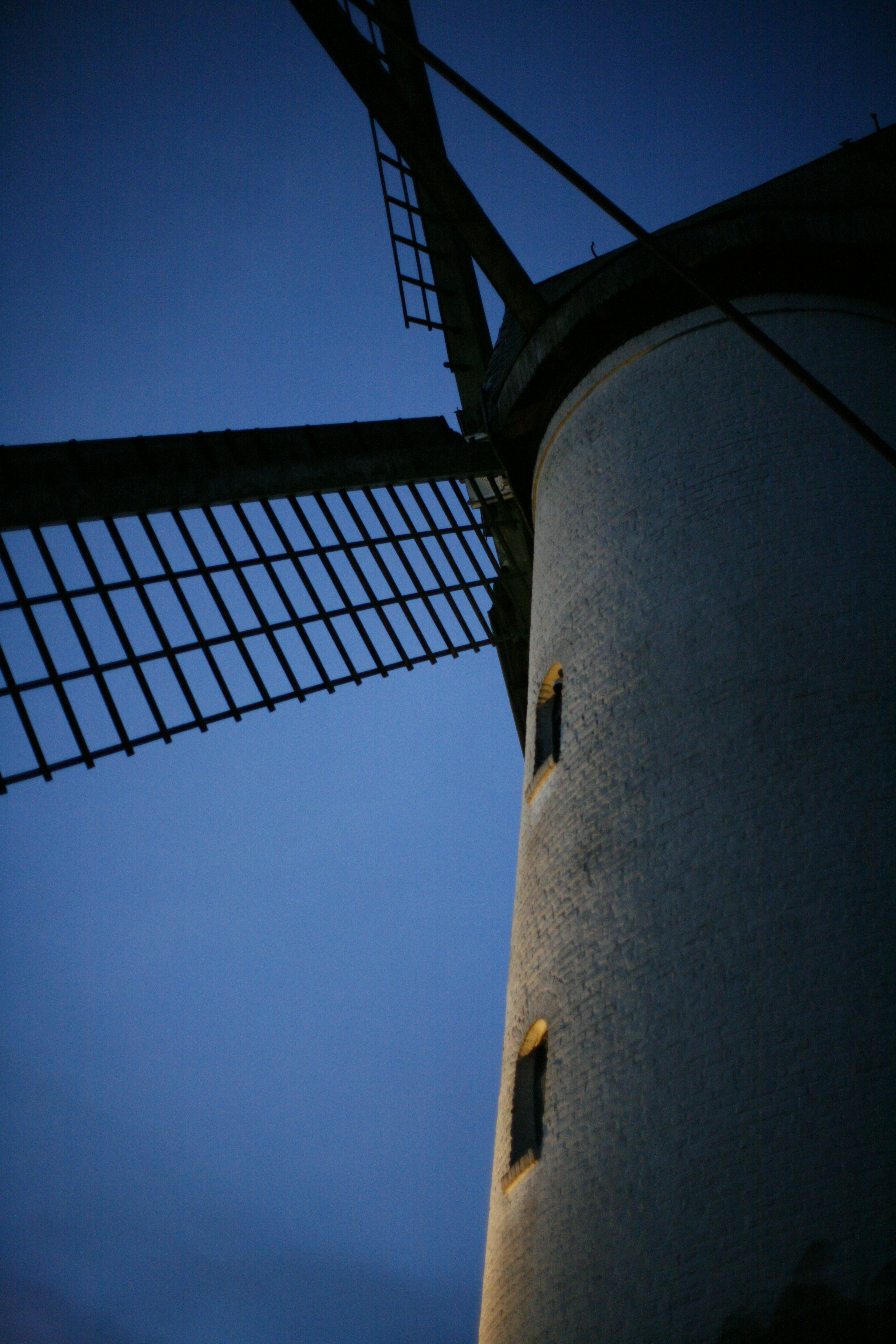 a windmill that is next to a building