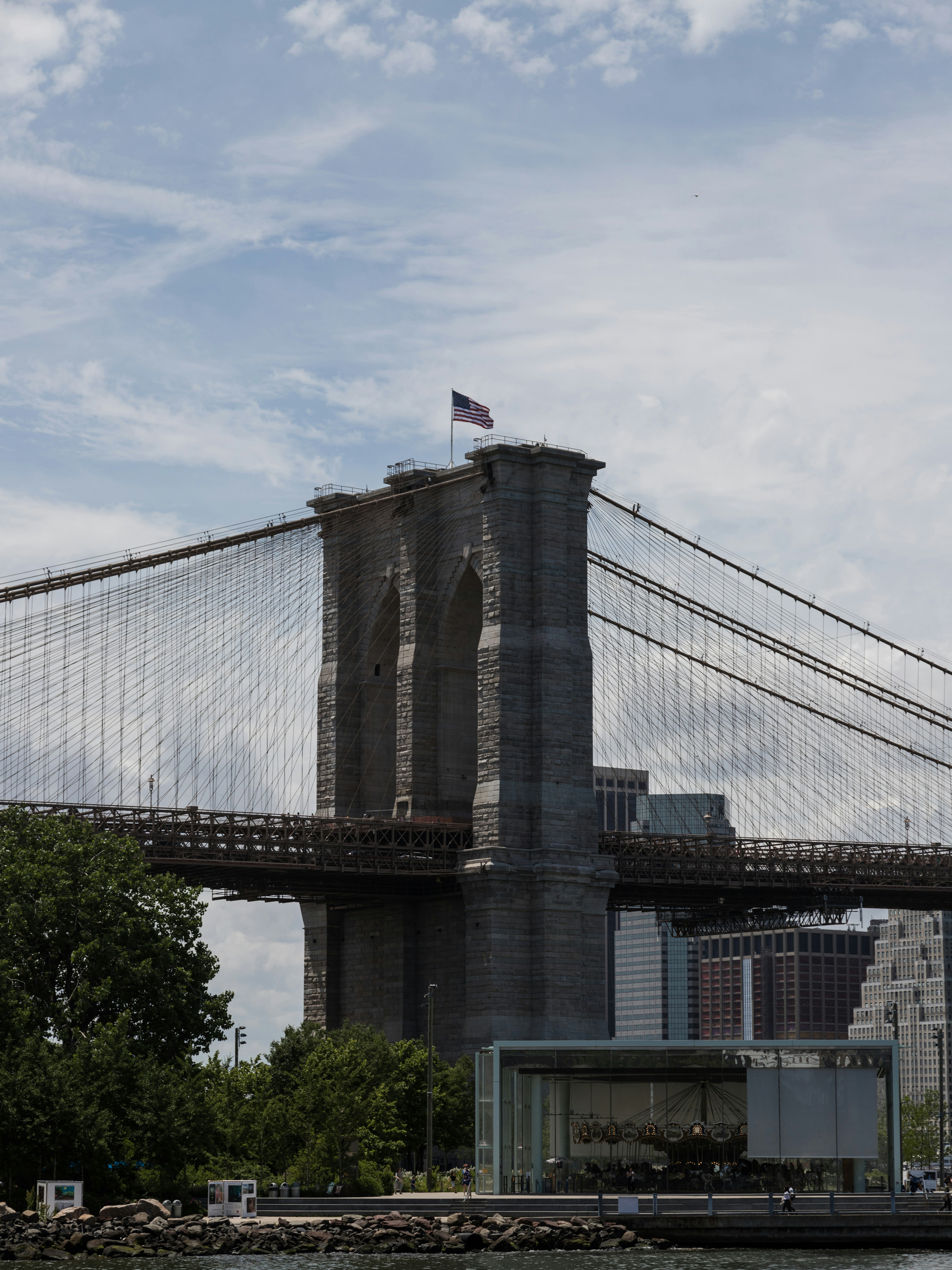 Flag atop Brooklyn Bridge Tower: Cables Carving the City Sky