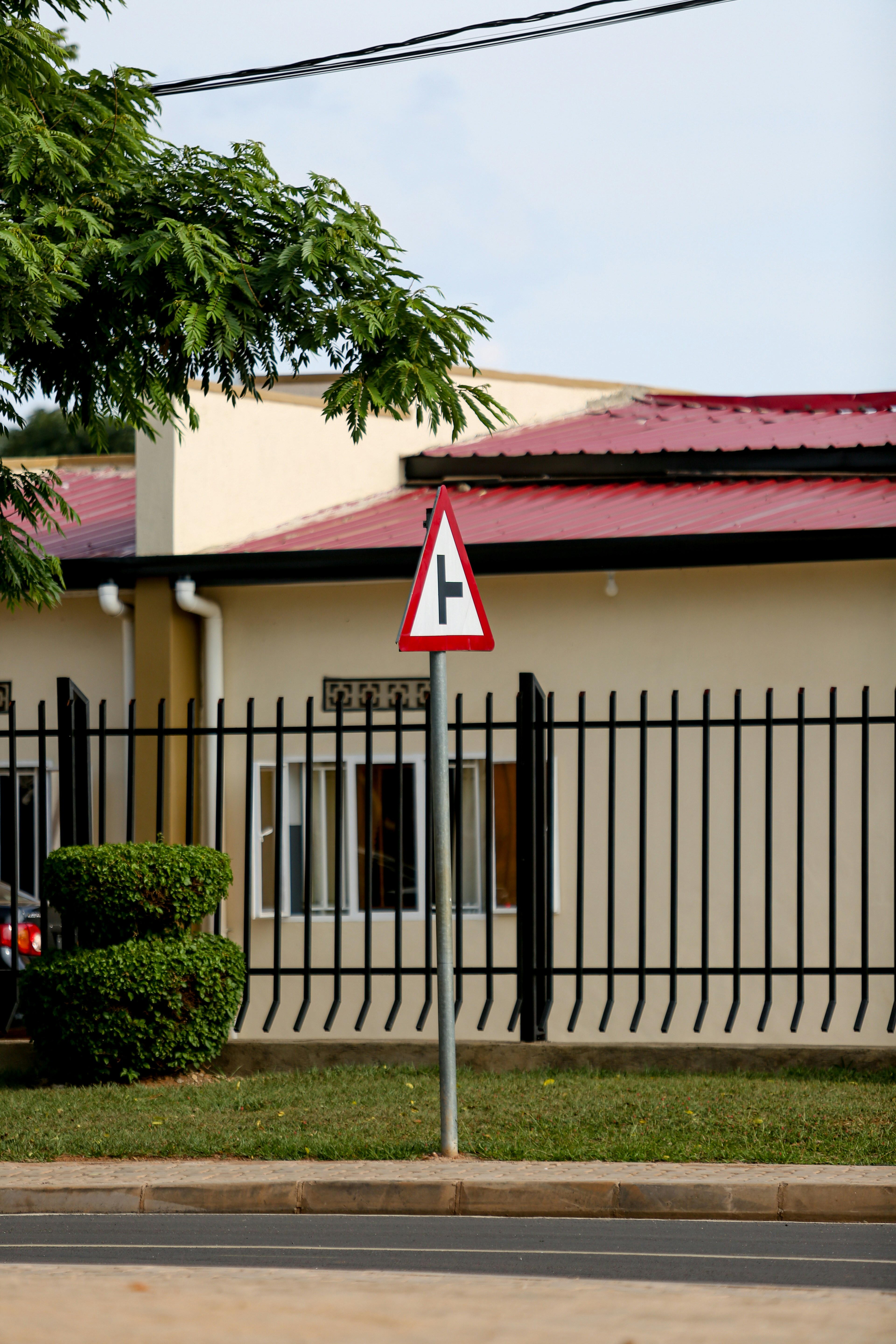 A red and white triangle sign sitting on the side of a road photo ...