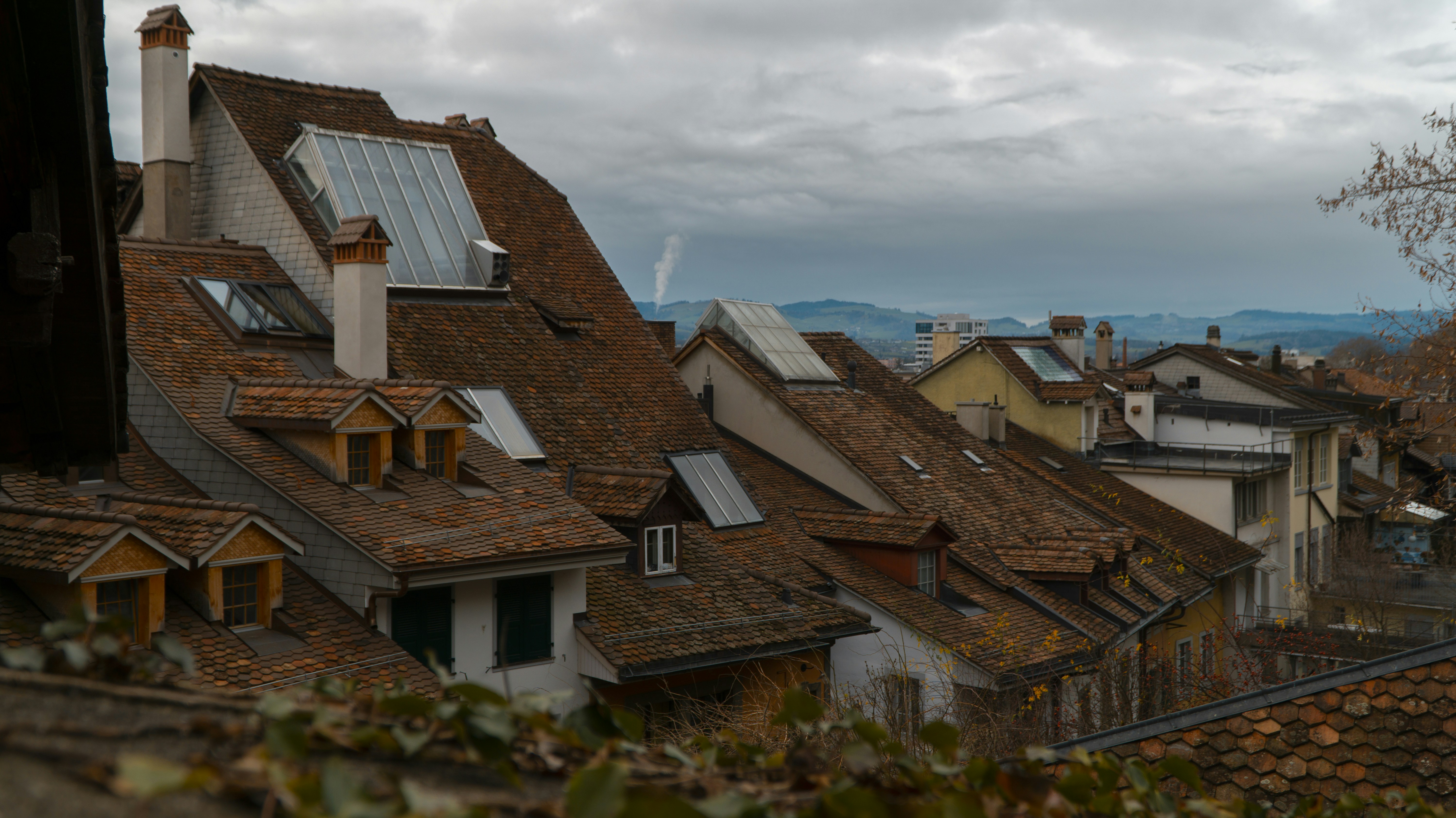 a row of houses with a cloudy sky in the background