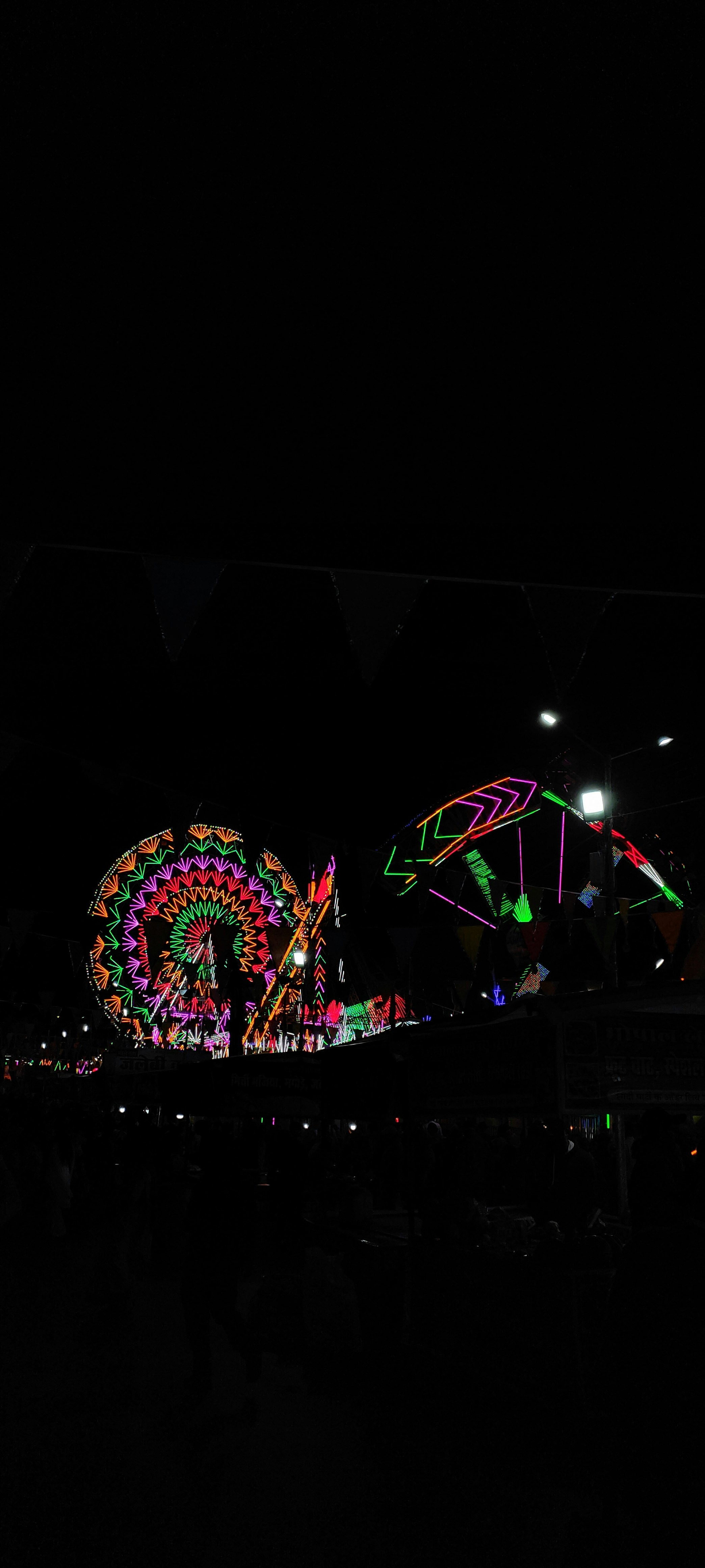 a carnival ride lit up at night in the dark