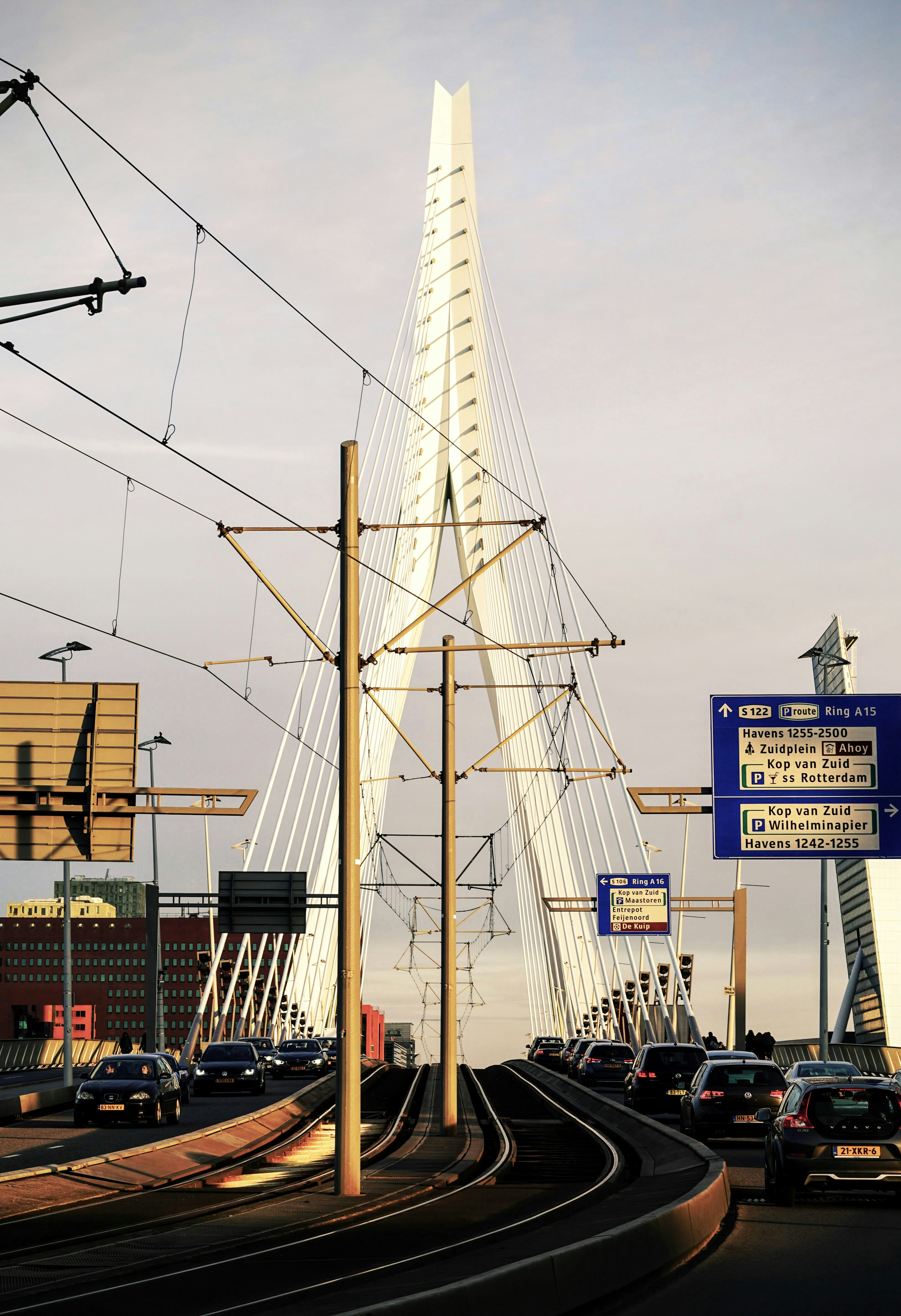a very tall white tower sitting on the side of a road
