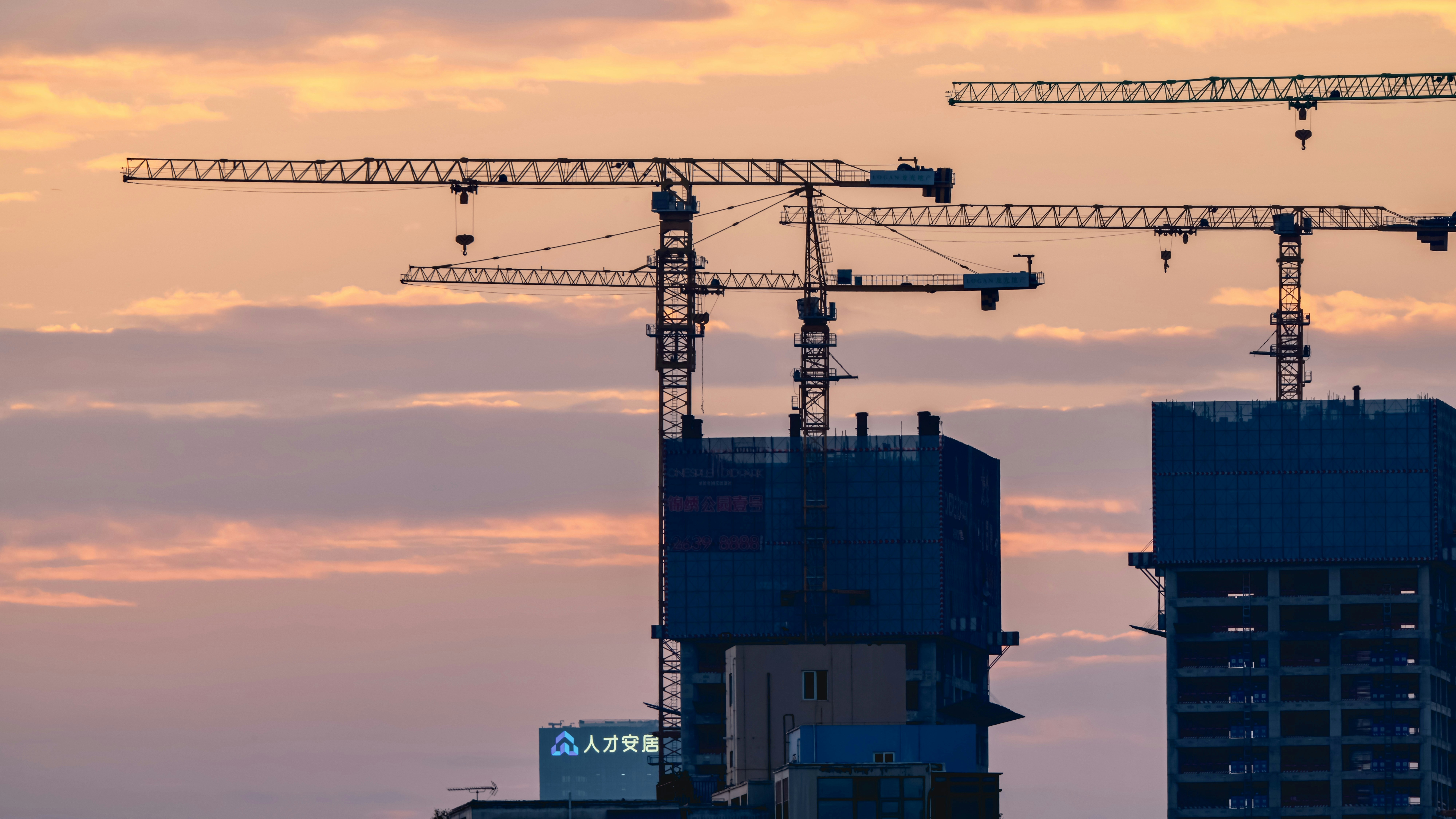 A couple of tall buildings under a cloudy sky photo – Free Construction ...