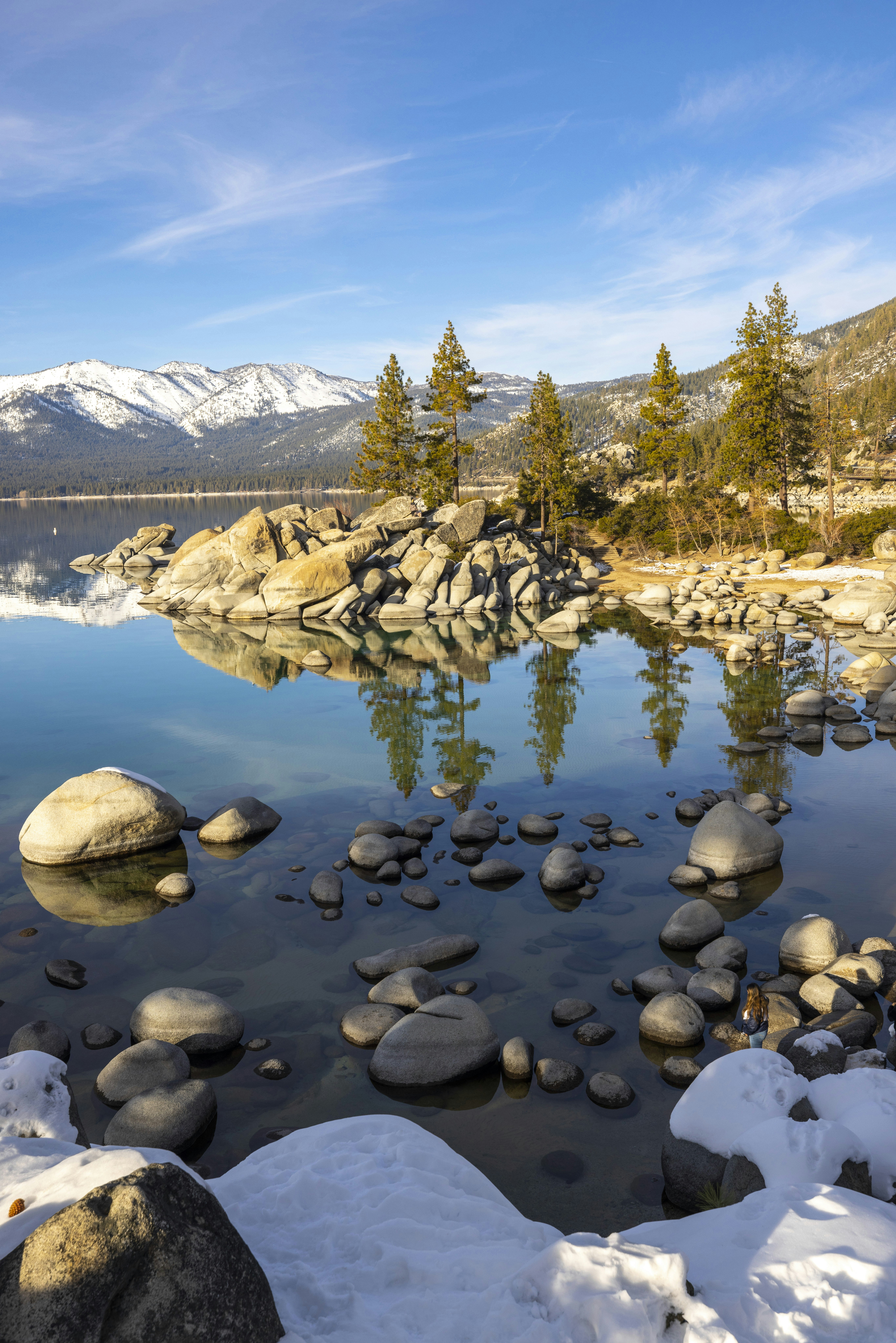A mountain lake surrounded by snow covered rocks photo – Free Sunset ...
