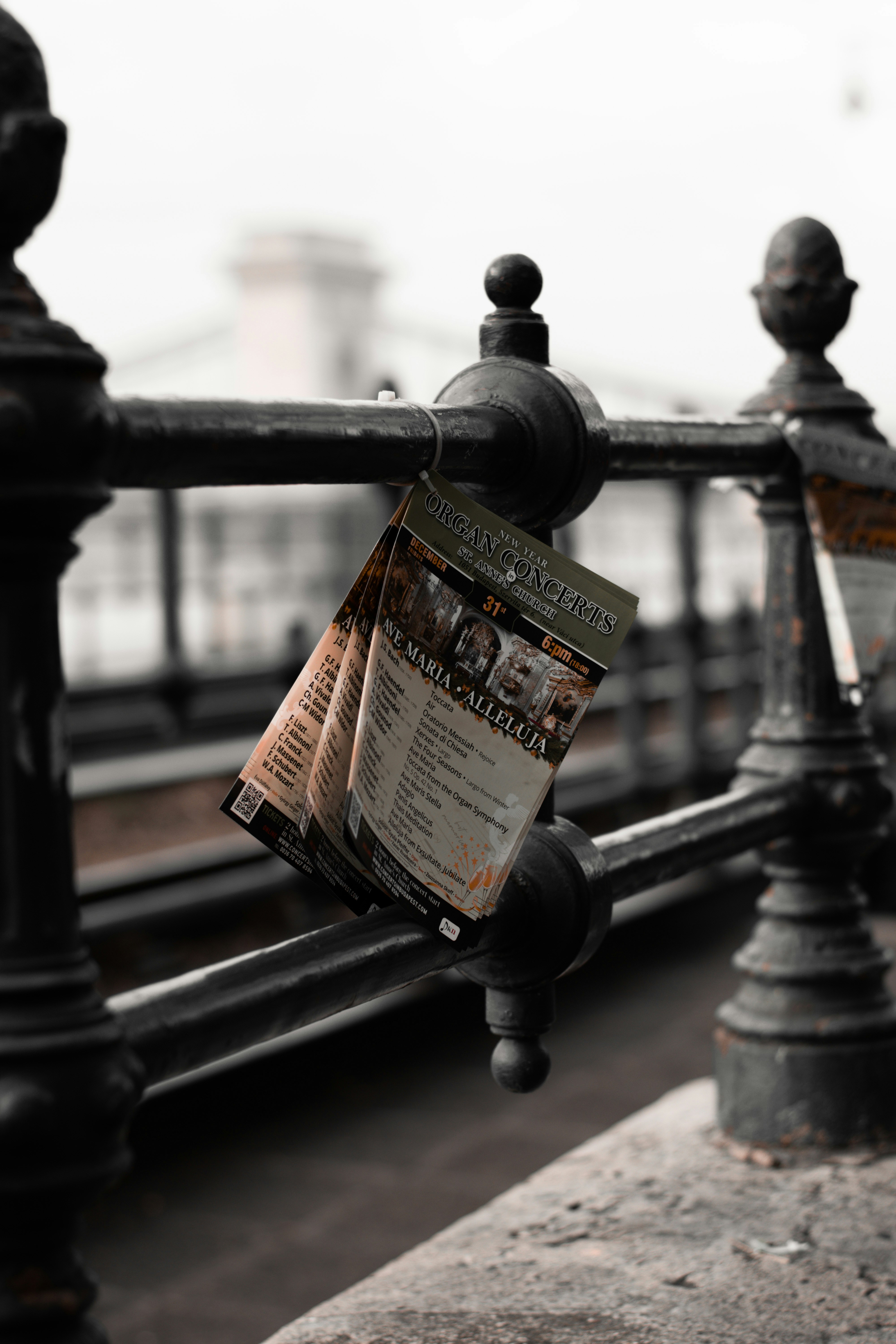 Ink and Iron: Concert Flyers Clinging to a Weathered Bridge Railing