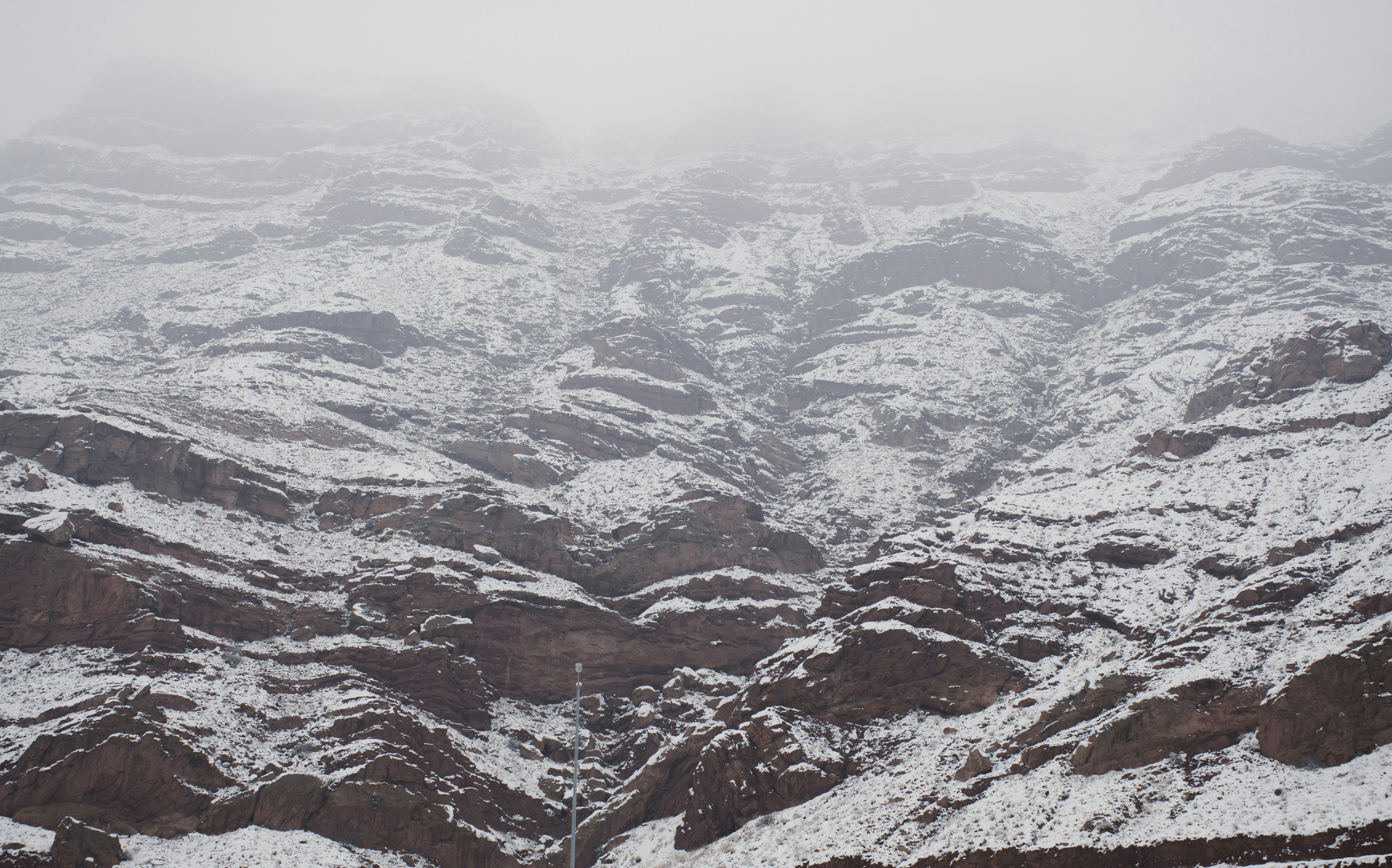 Mist-Softened Ridges under a Winter Veil