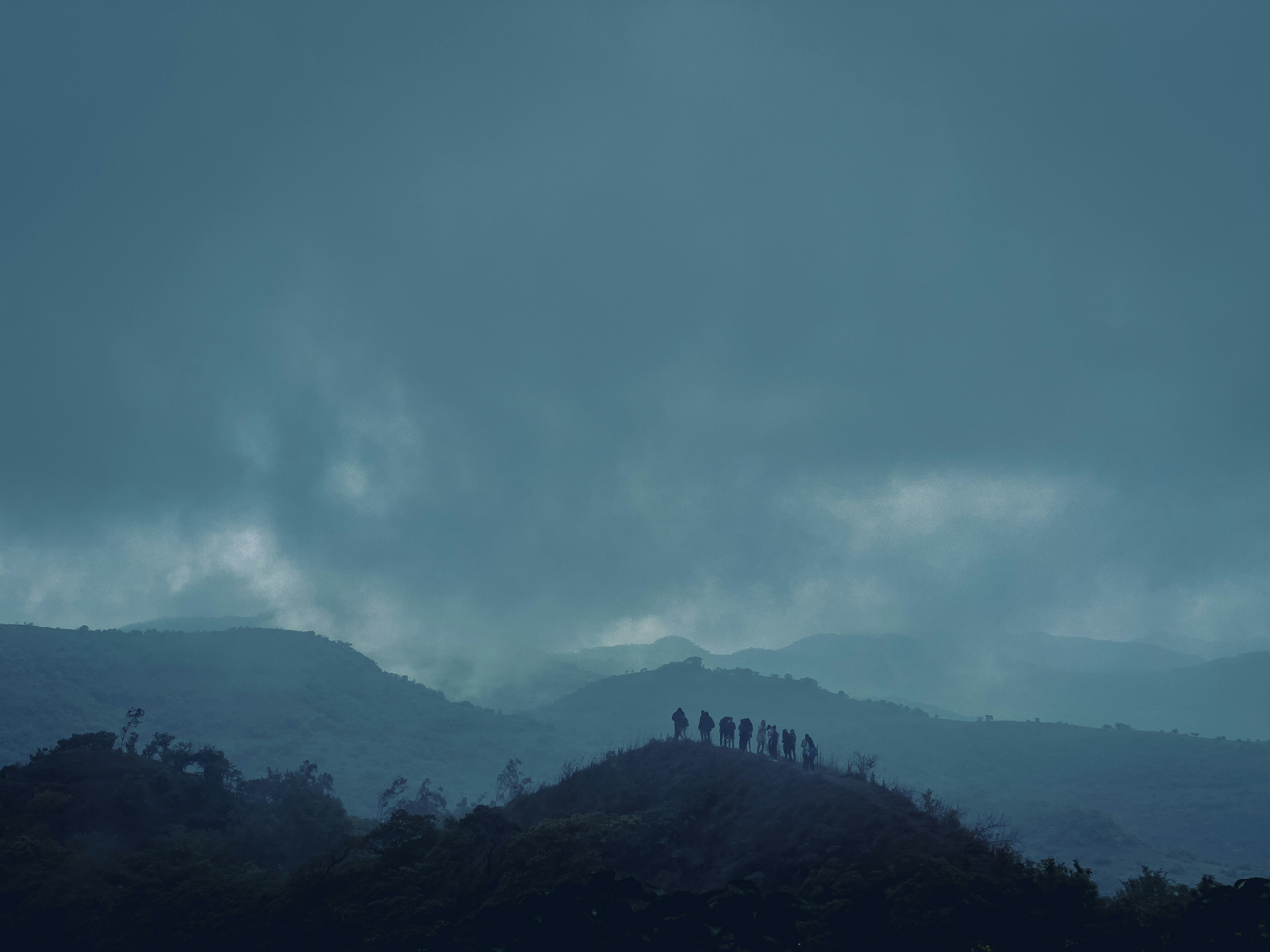 Silhouetted Hikers on a Misty Blue Ridge at Dawn