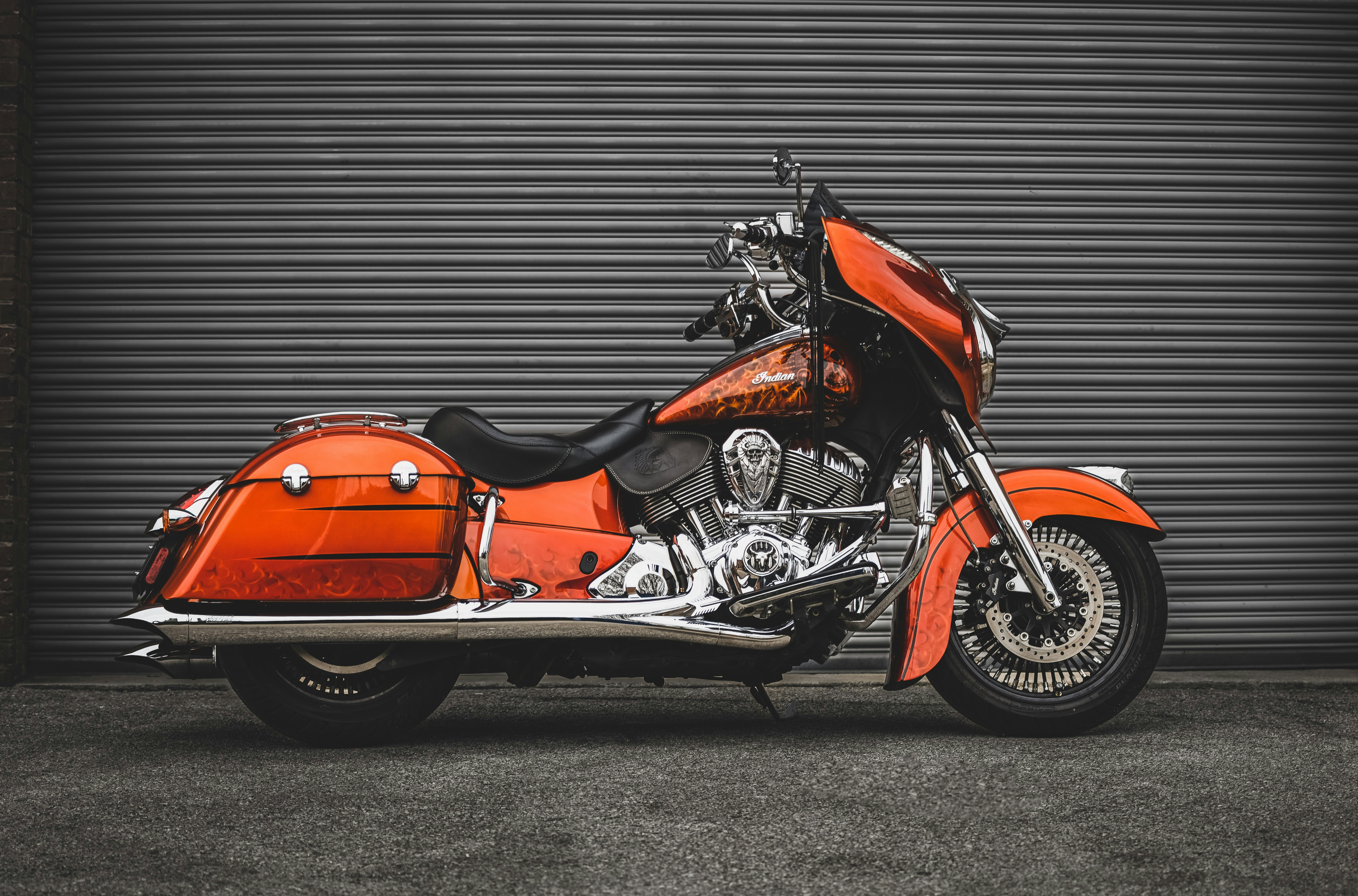 Crimson Road: Classic Cruiser Resting Against Industrial Tracks