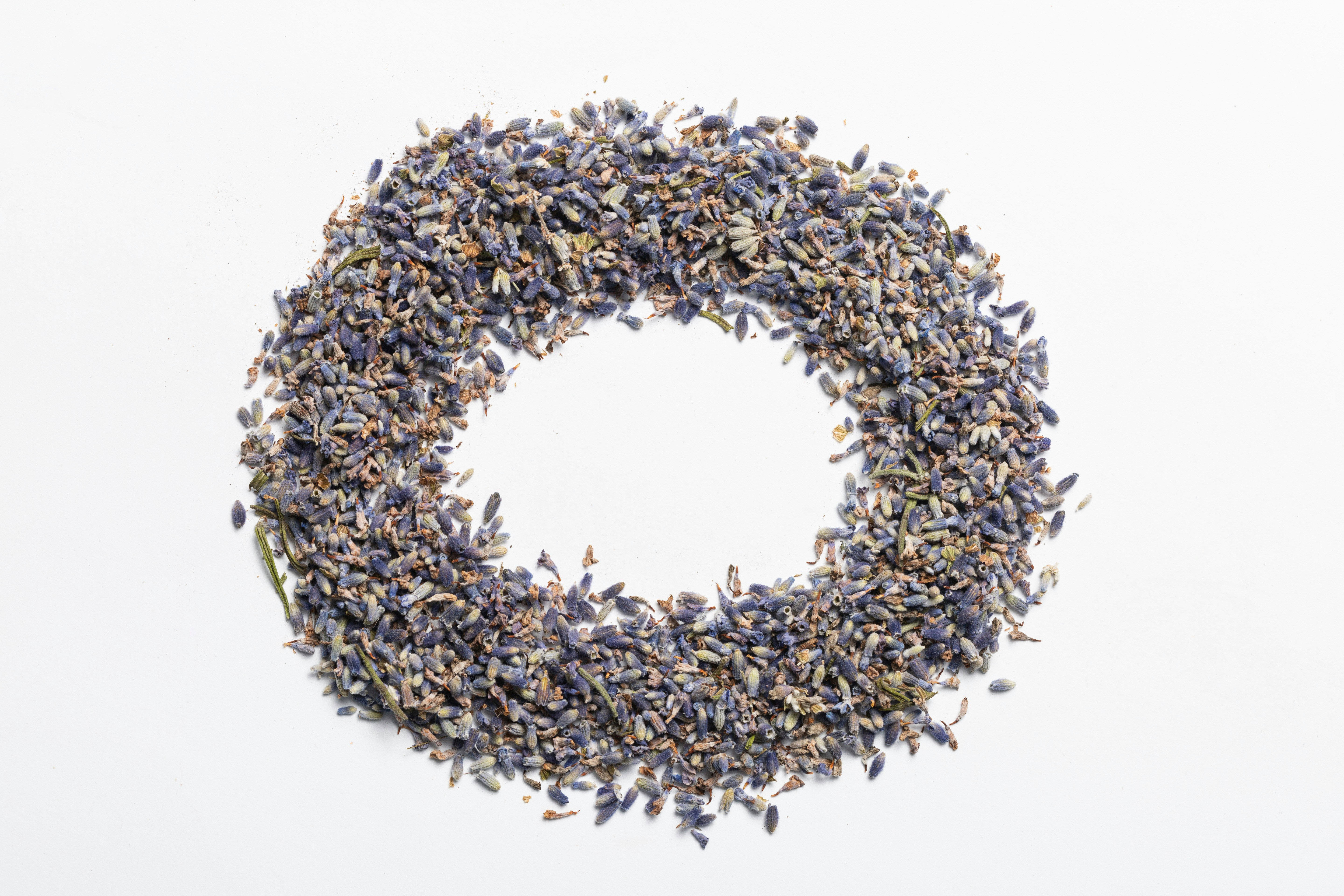 A circle of lavender sprinkles on a white background photo – Free ...