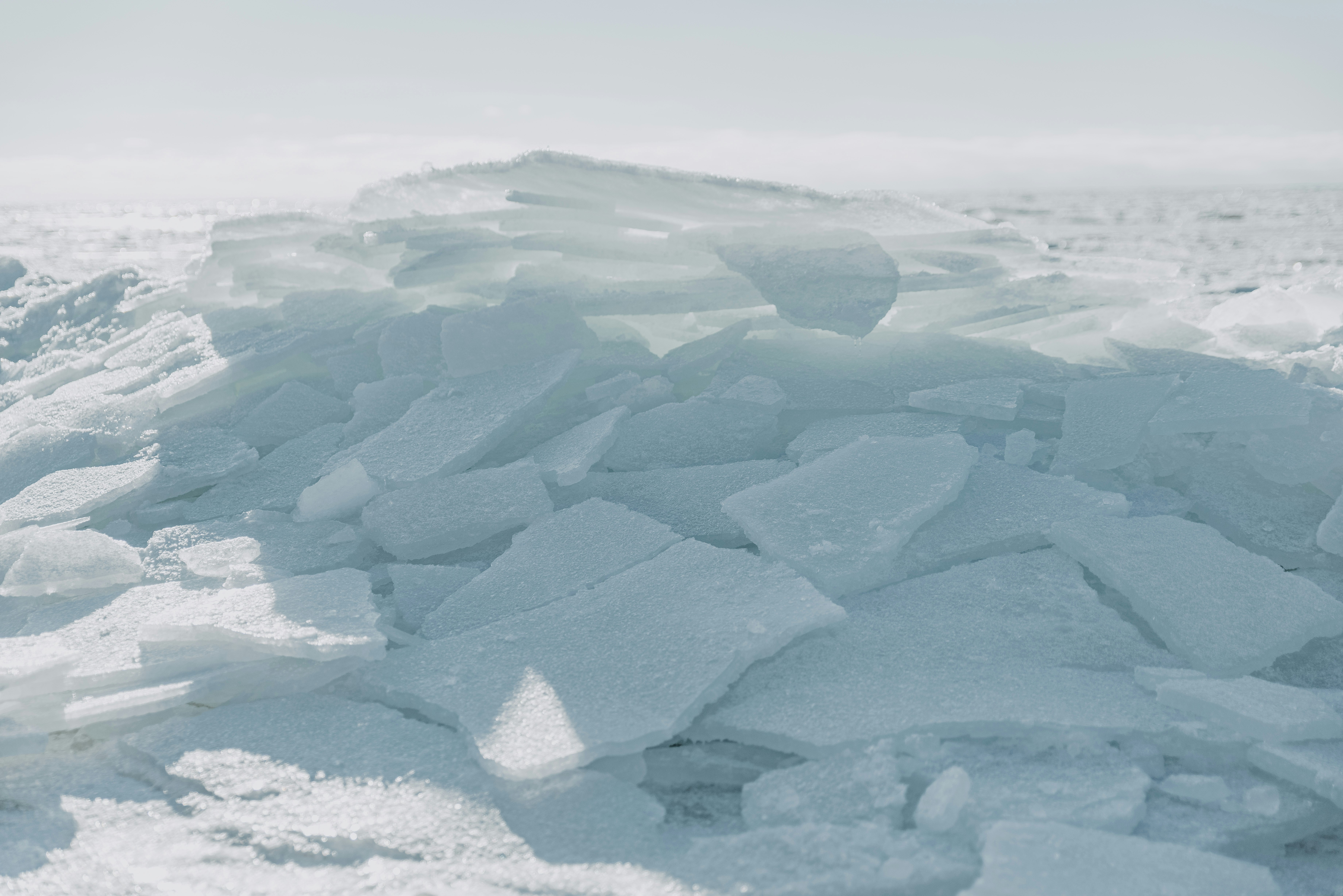 A pile of ice blocks on a snowy surface photo – Free Ice Image on Unsplash