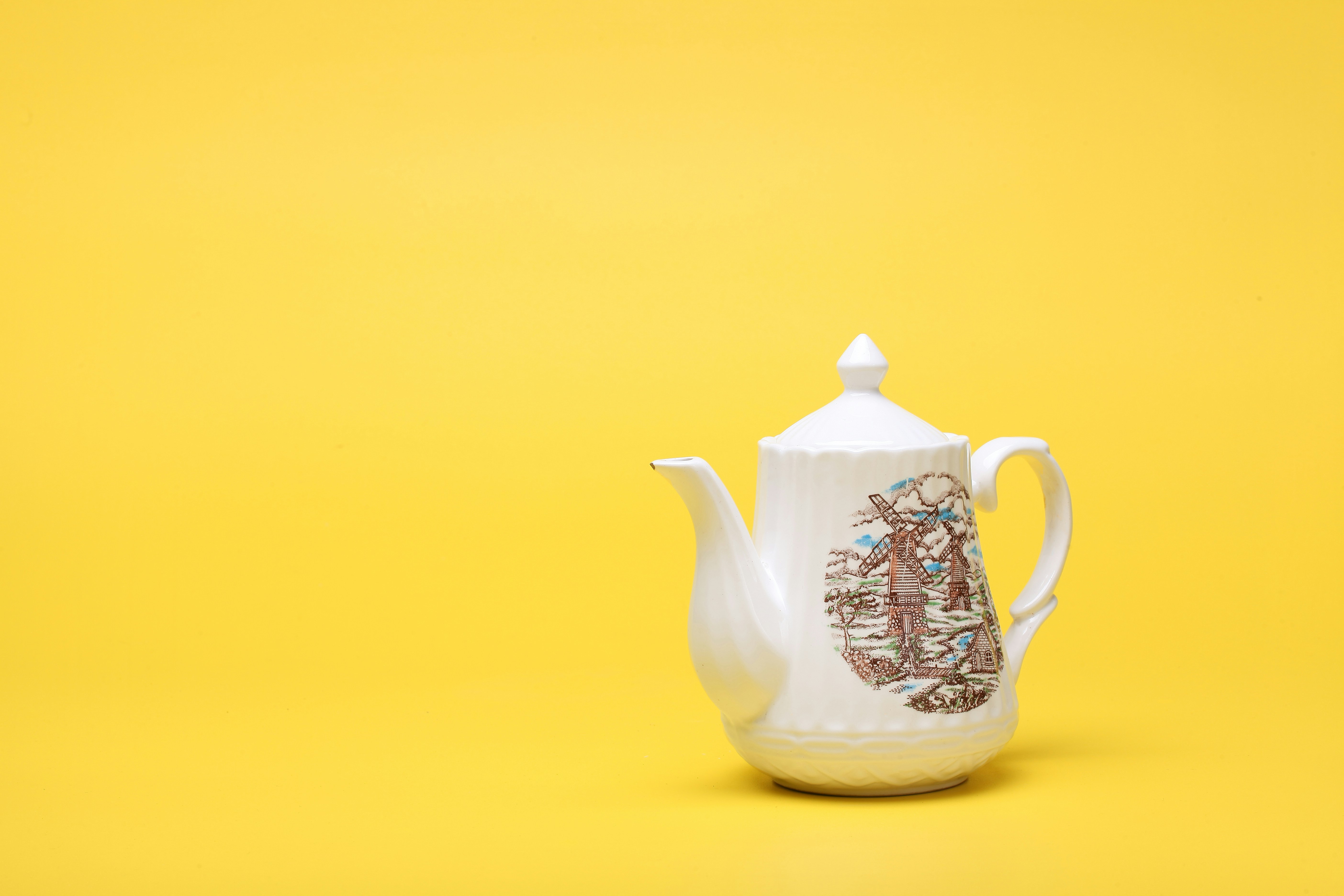 Porcelain Teapot on a Canary Backdrop