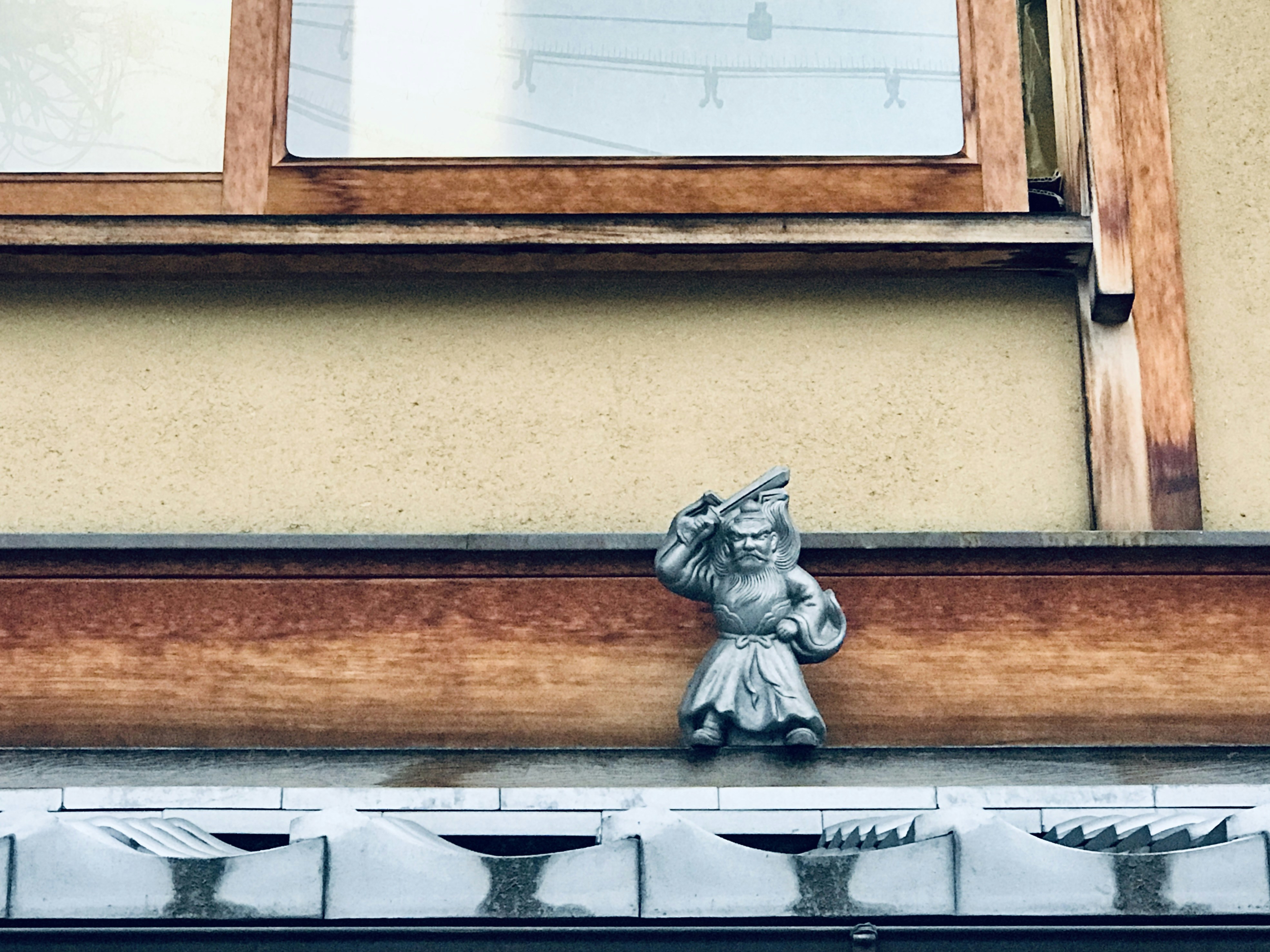a statue of a person holding a bird on a building