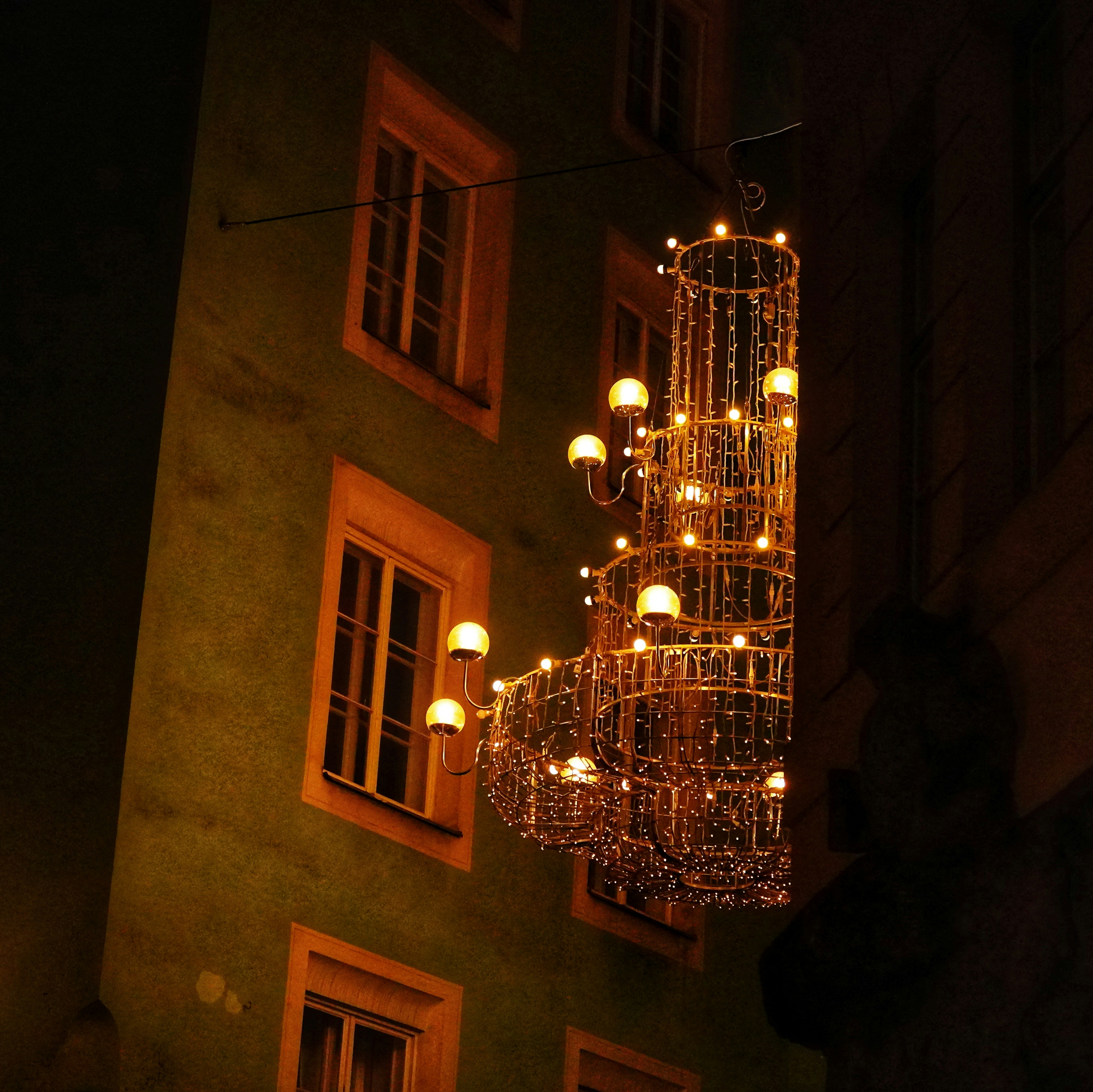 a chandelier hanging from the side of a building