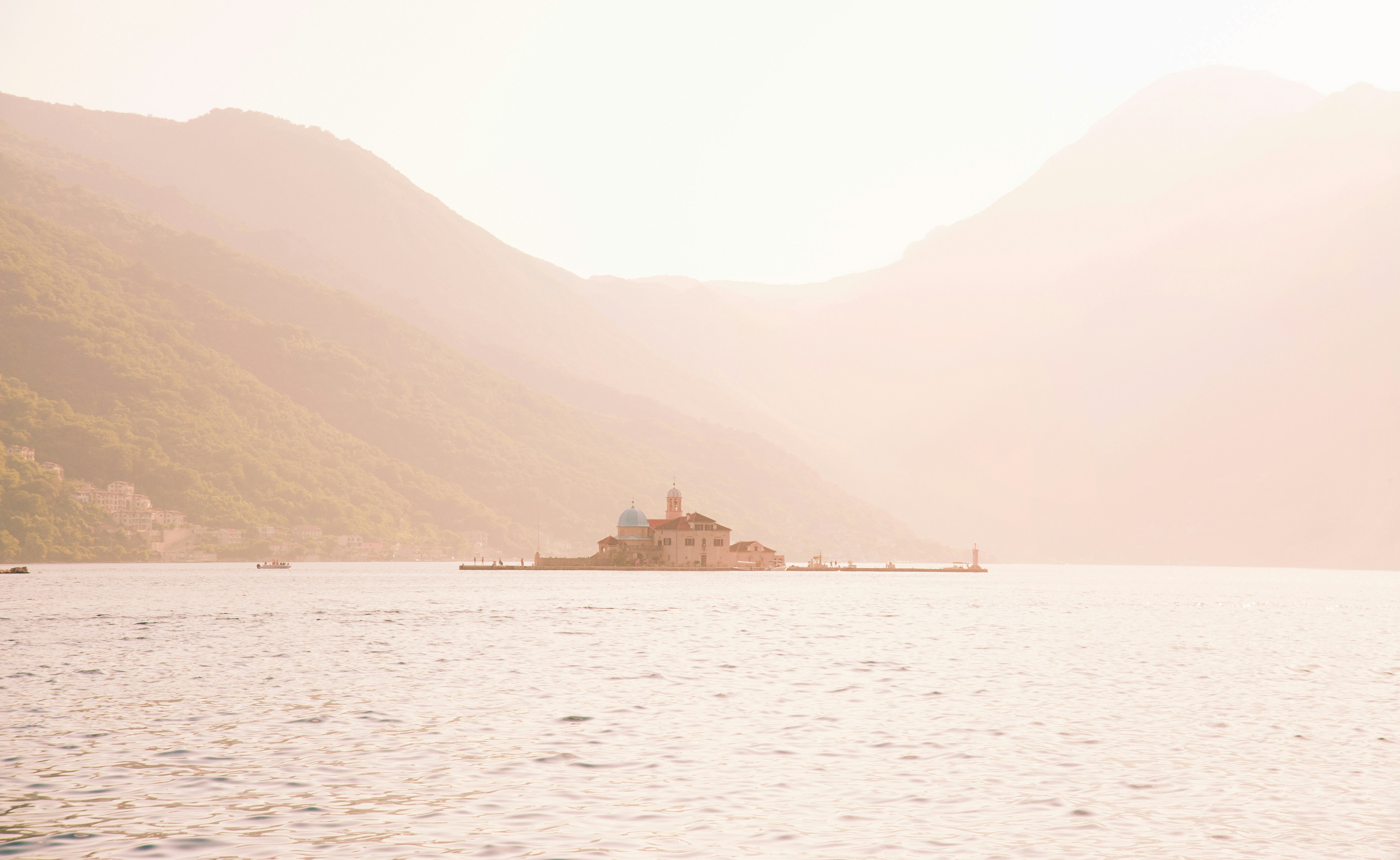 a large body of water with a small island in the middle of it