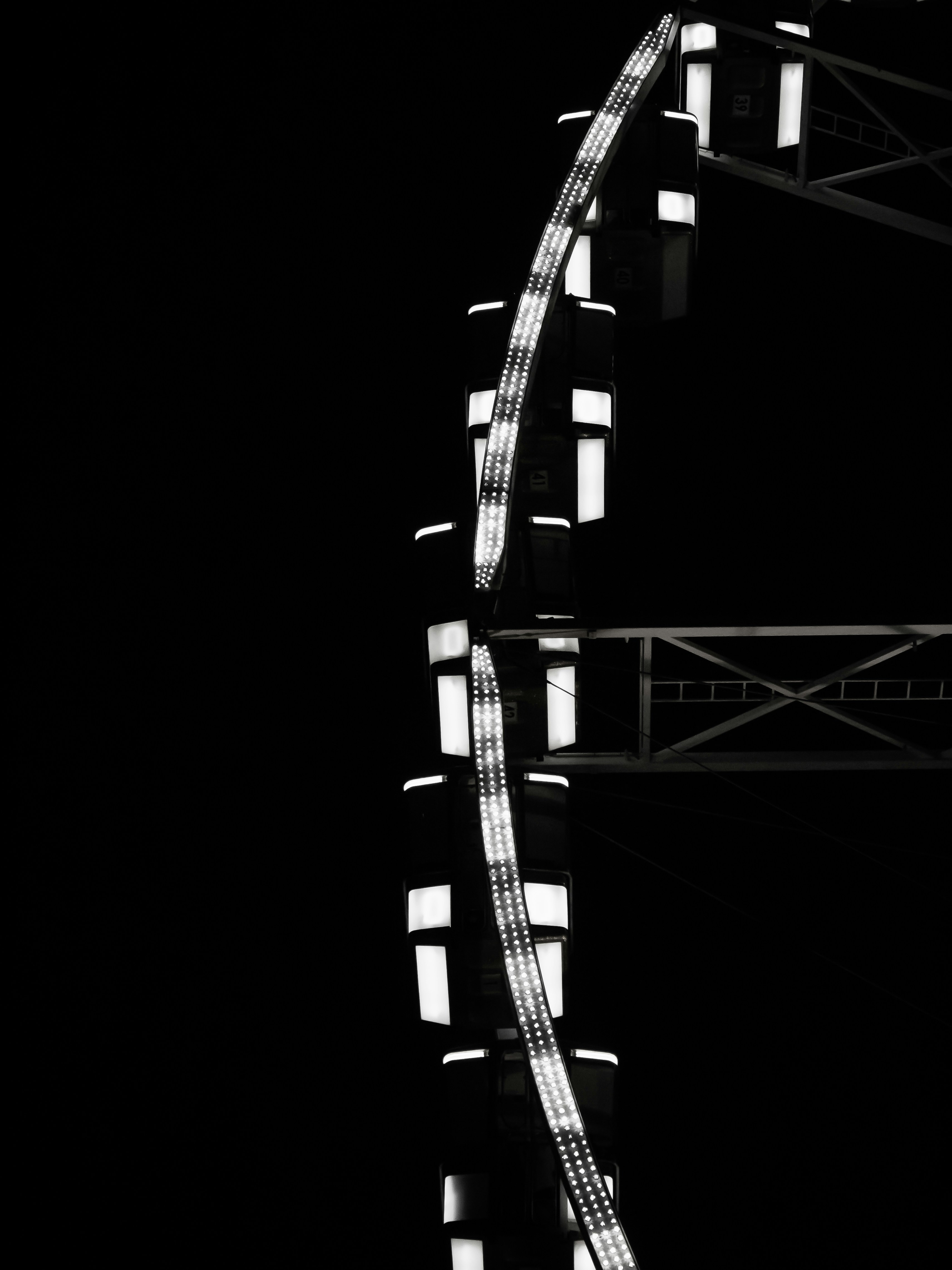 Midnight Arc: A Neon Curve of Light on a Ferris Wheel