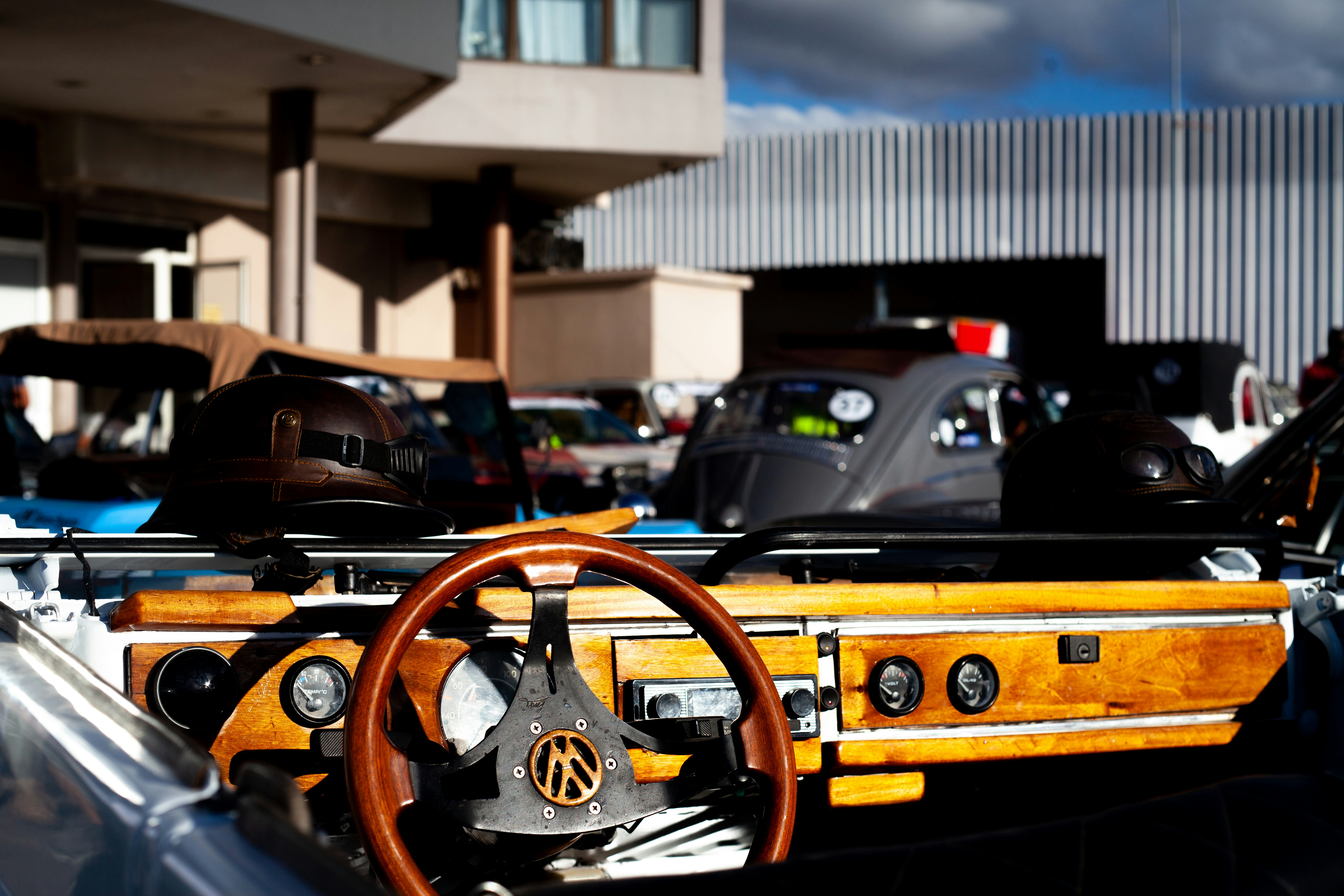 Wooden Steering Wheel Reverie in a Row of Classic Cars