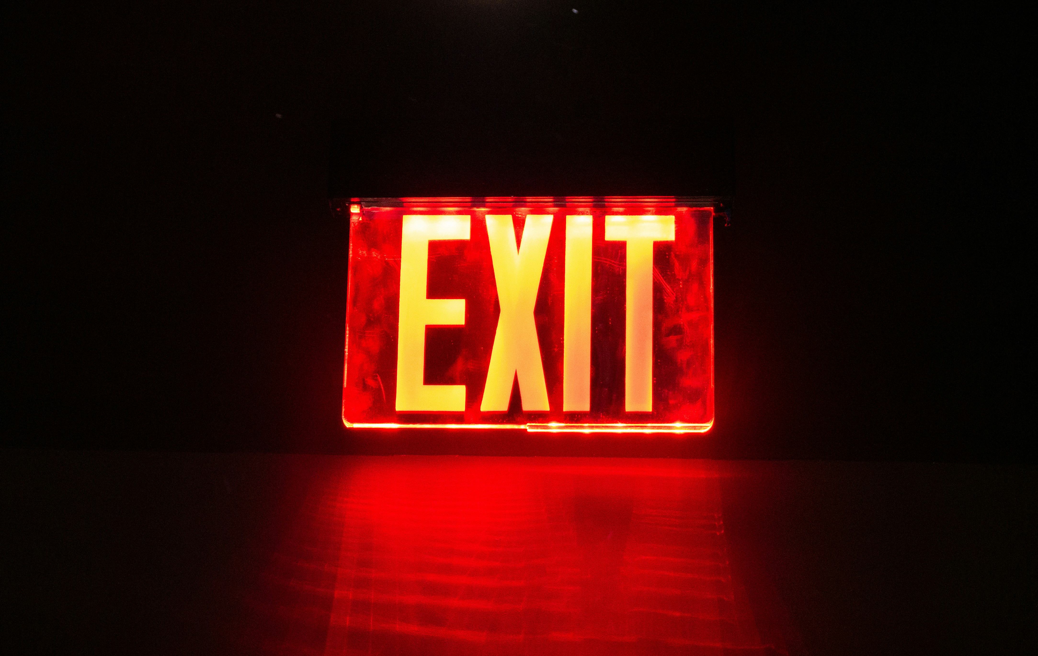 A red exit sign lit up in the dark photo – Free Manchester city centre ...