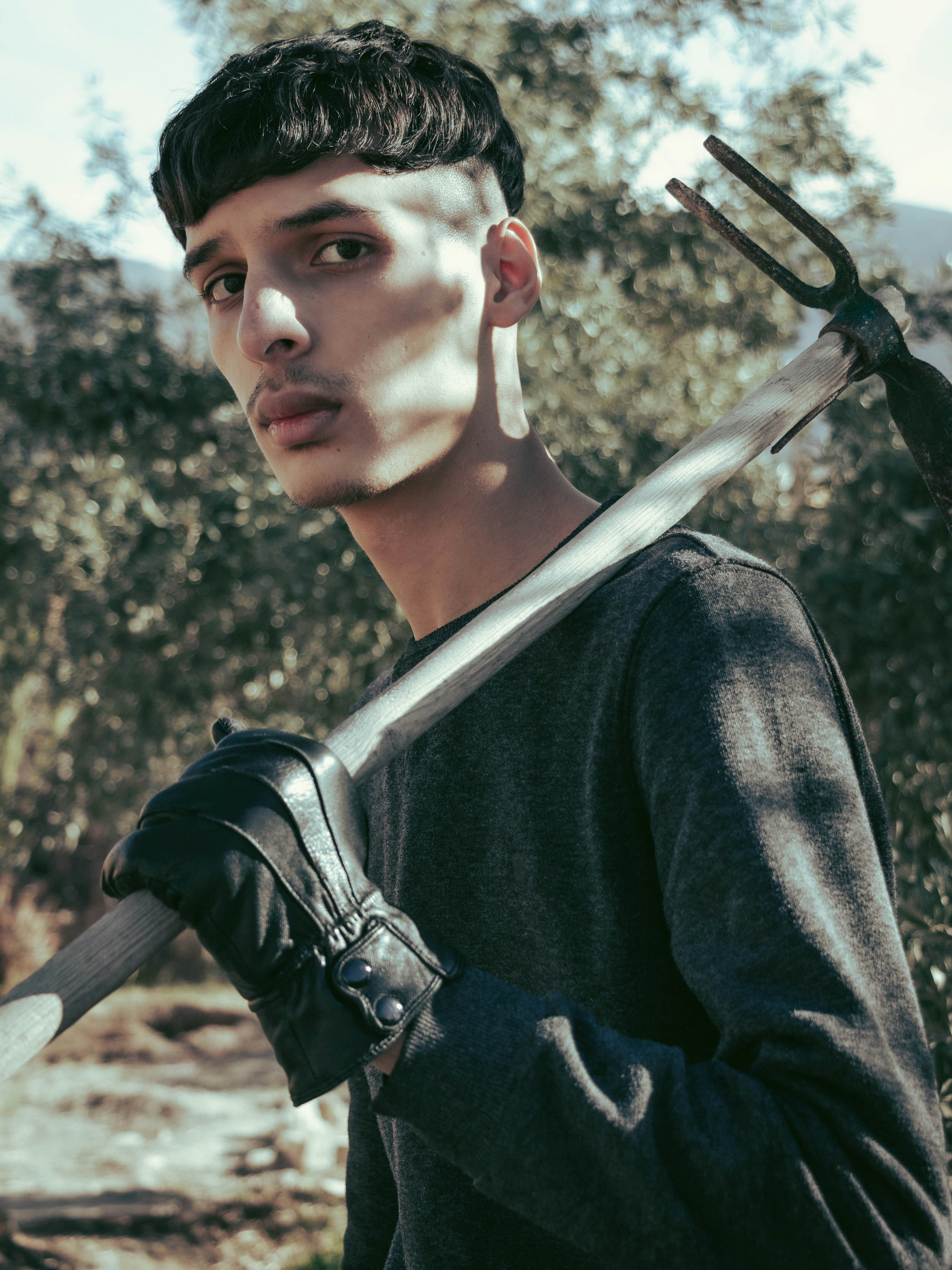 Harvested Night Sky: A Youth with a Pitchfork in Sunlit Silence