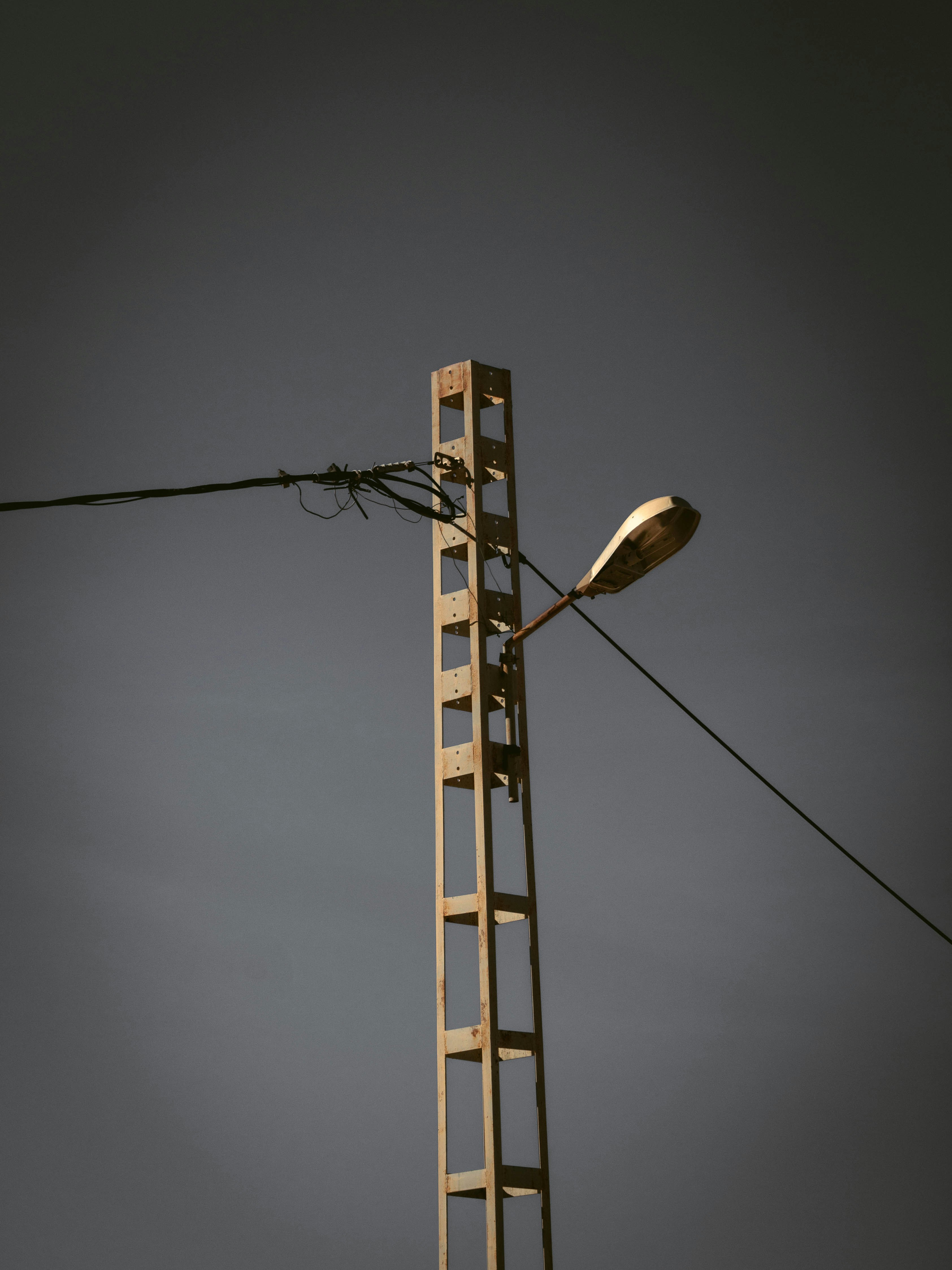 Lamp Post and Wire in a Quiet Sky