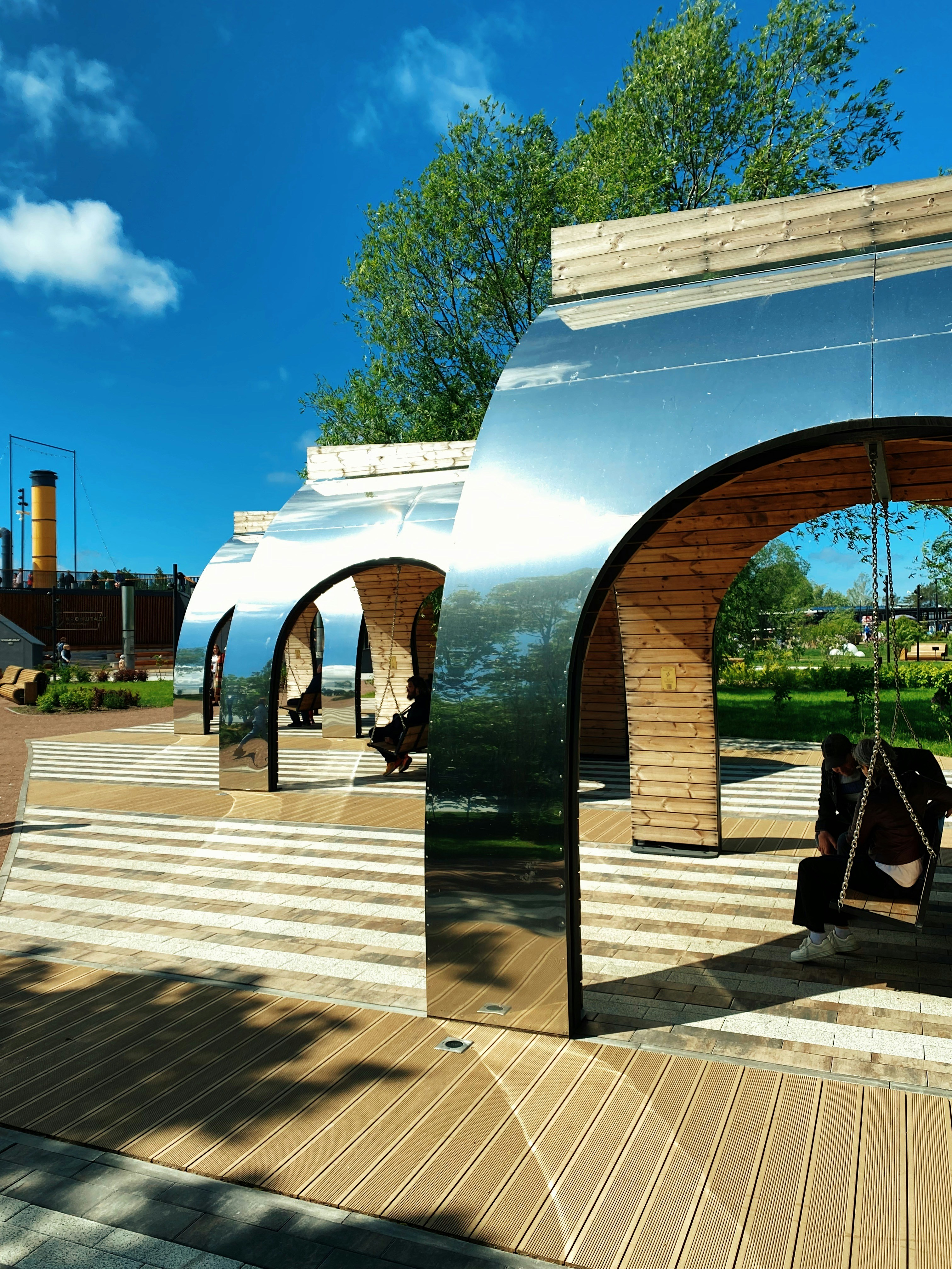 A large metal structure sitting on top of a wooden deck photo – Free ...