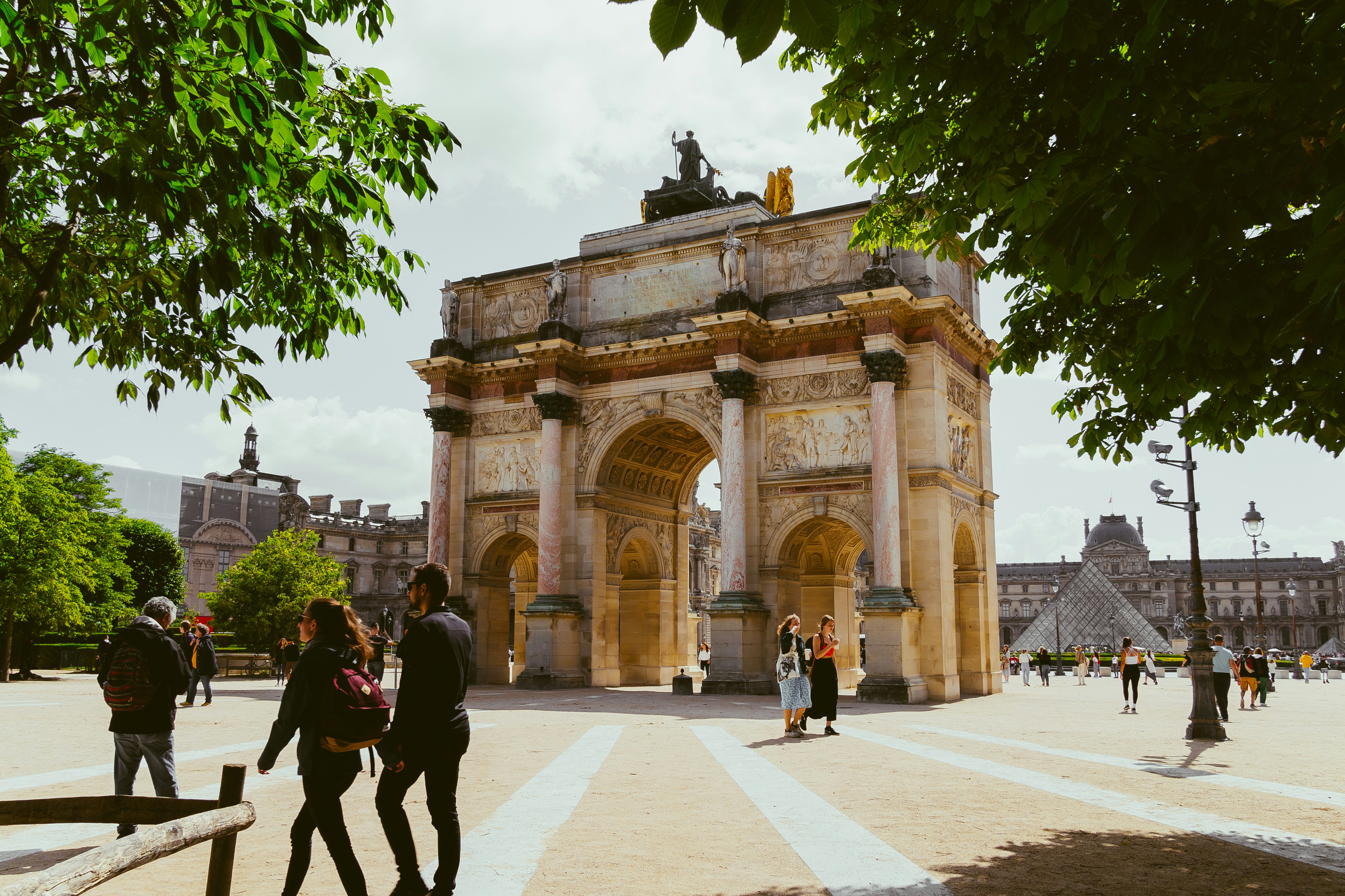 A group of people standing in front of a stone arch photo – Free Street ...