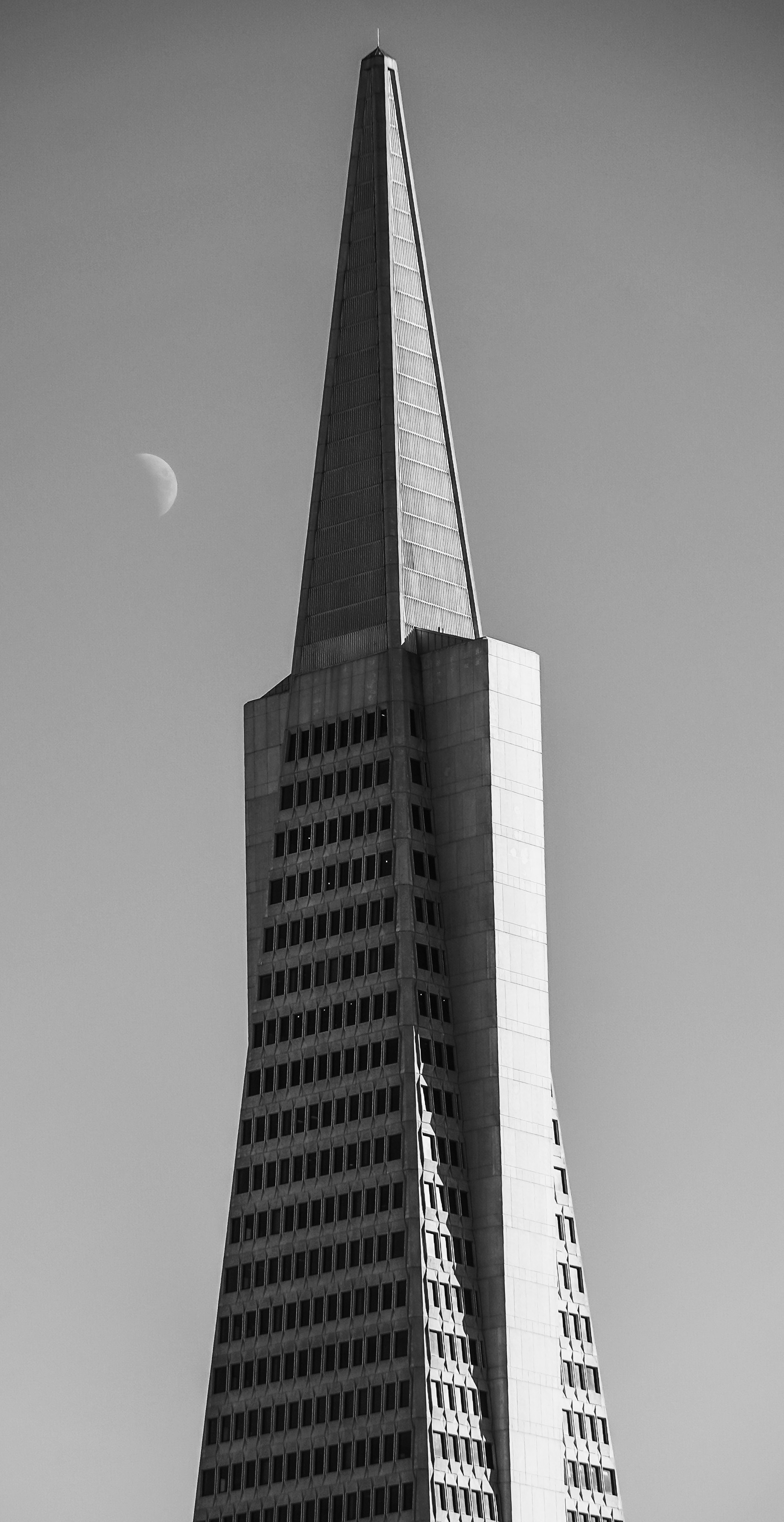 a black and white photo of a very tall building