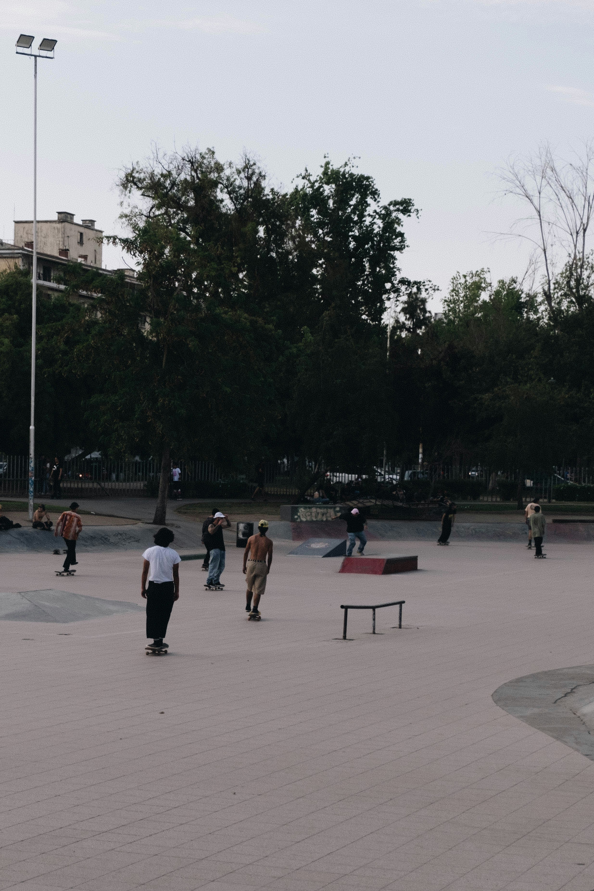 A group of people walking around a skate park photo – Free Santiago ...