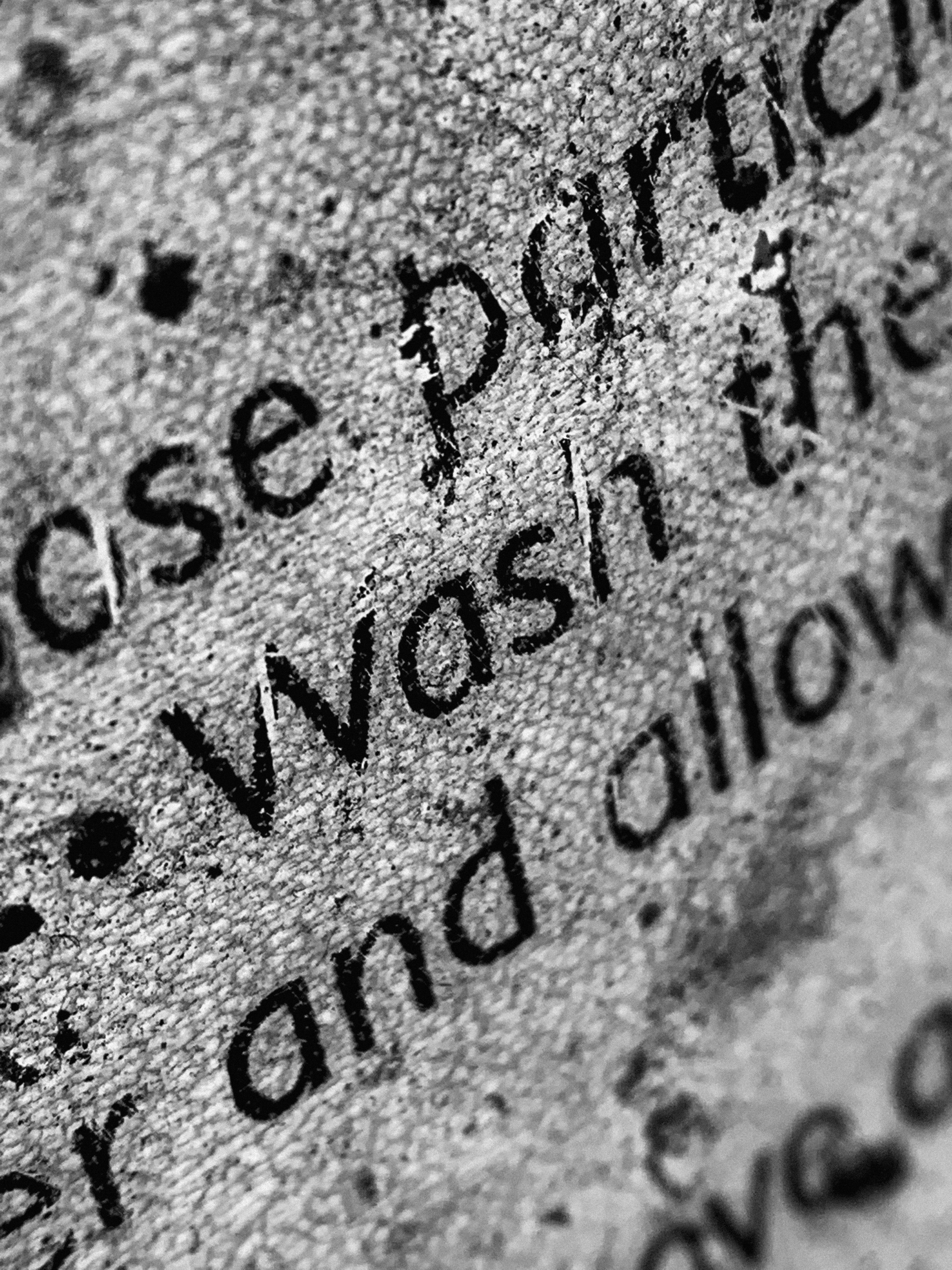 a black and white photo of graffiti on a wall