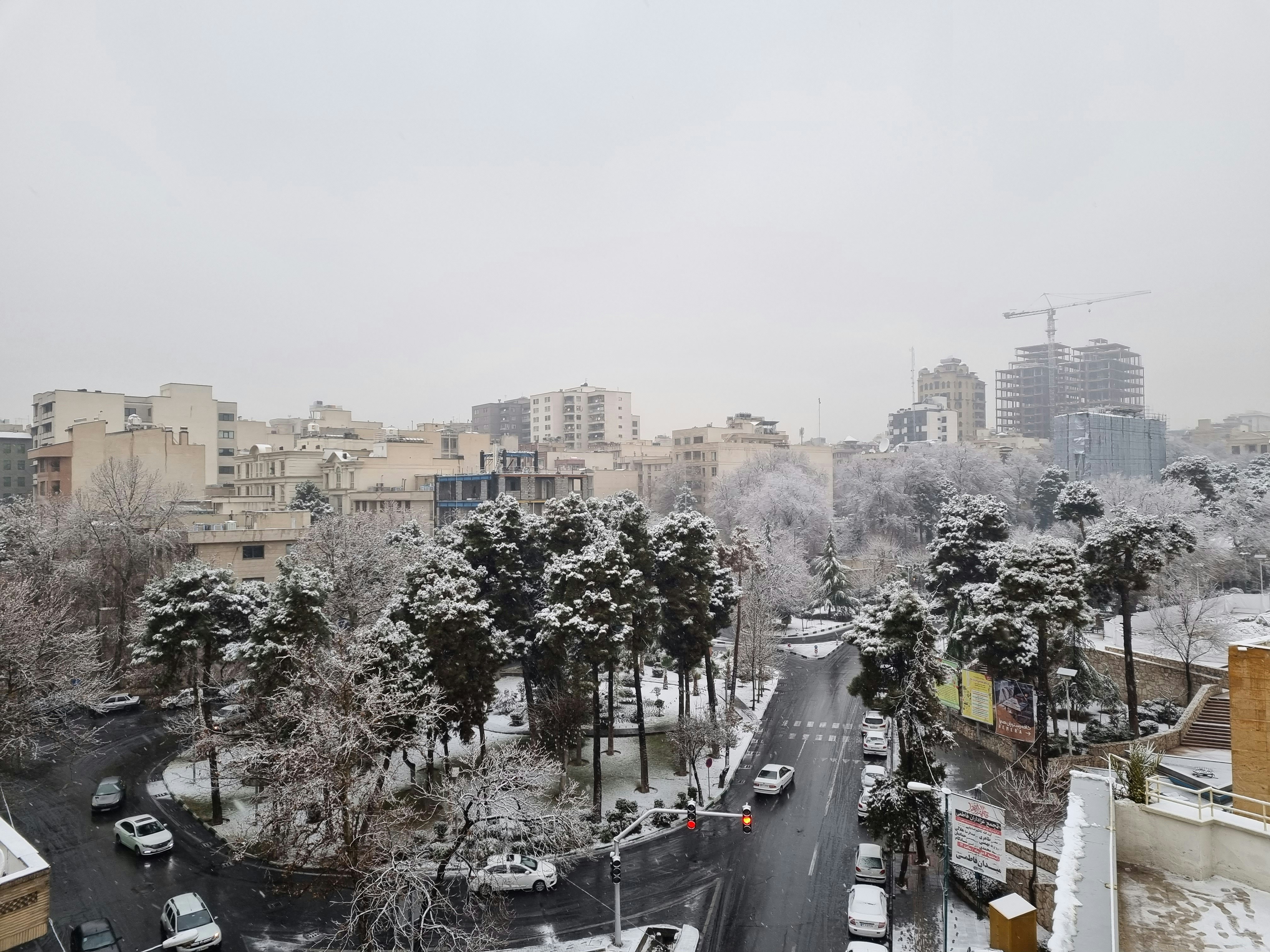 A city street is covered in snow in the winter photo – Free Tehran ...