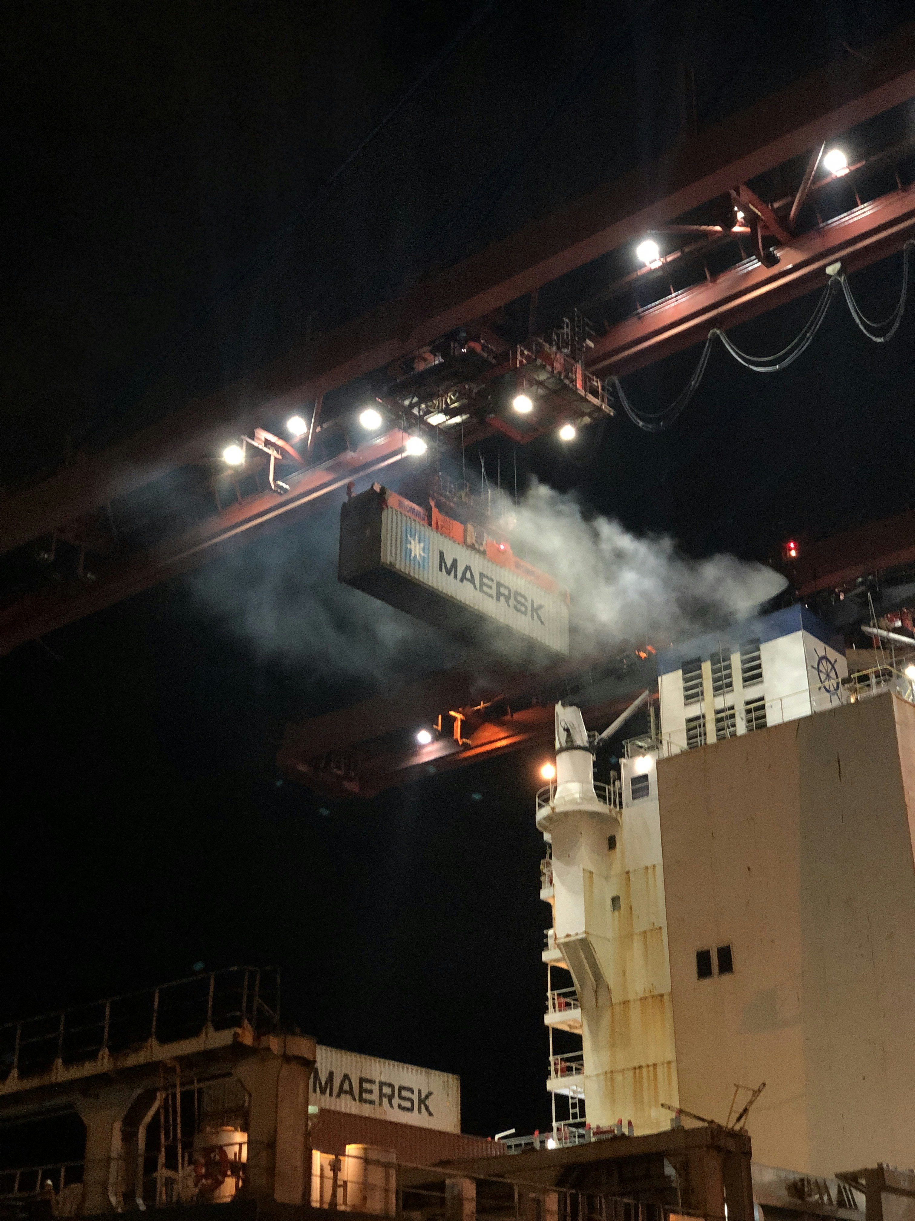 Night Lift Over Maersk: Smoke Trails and Crane Lights