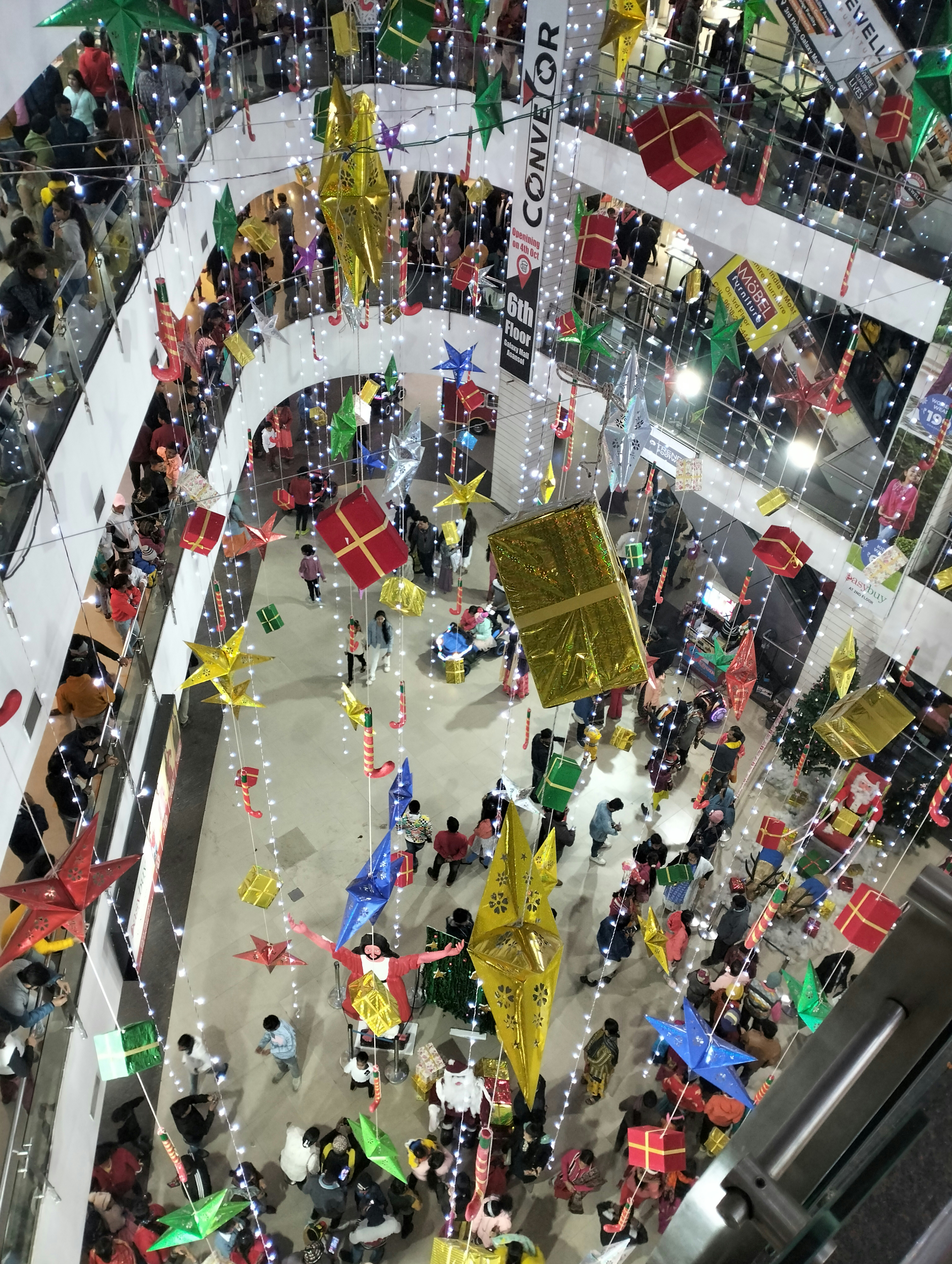 Centric Festivity: Aerial Cascade of Lights Over a Multilevel Atrium