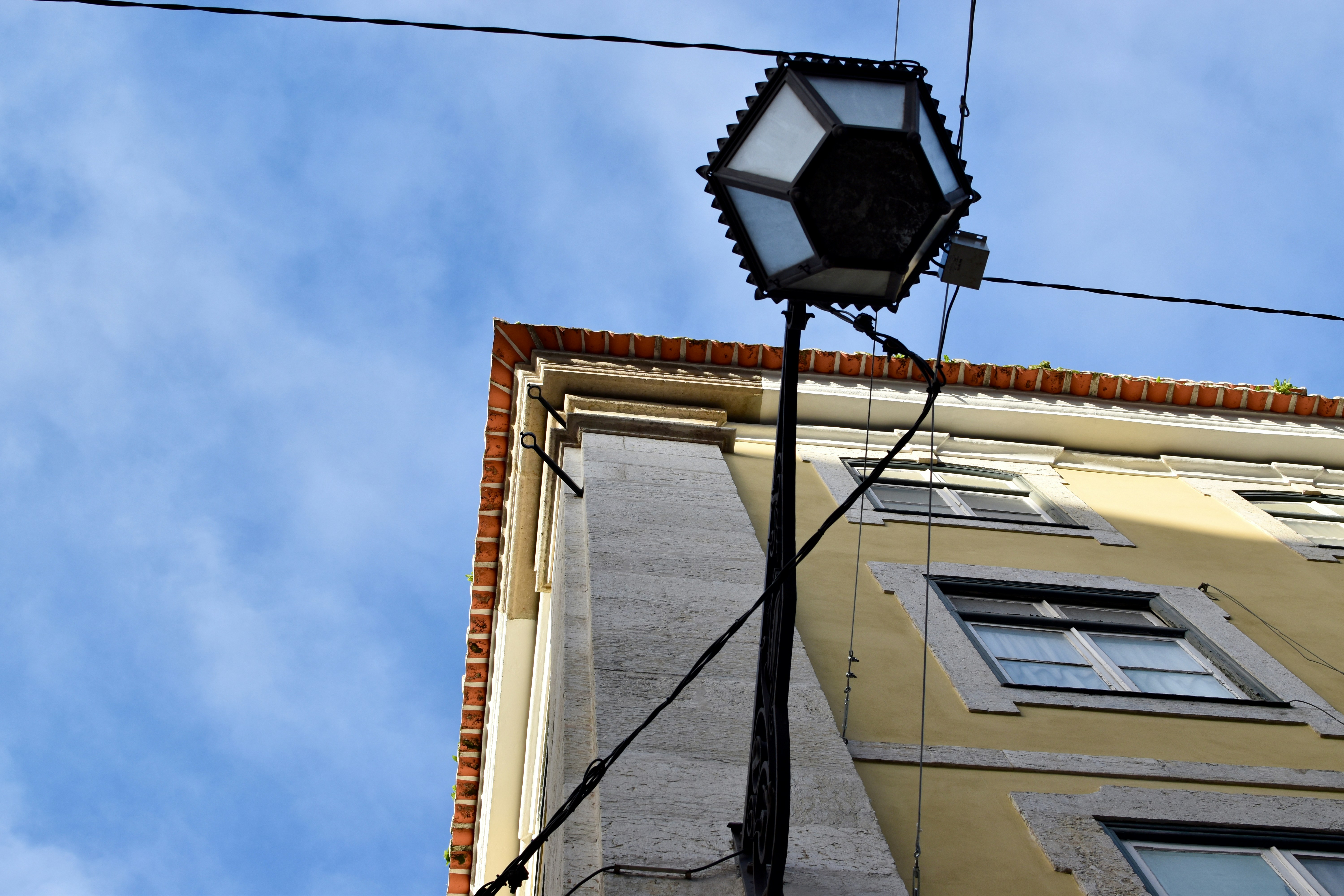 Tilted Lantern Above a Sunlit Facade: An Urban Geometry Portrait