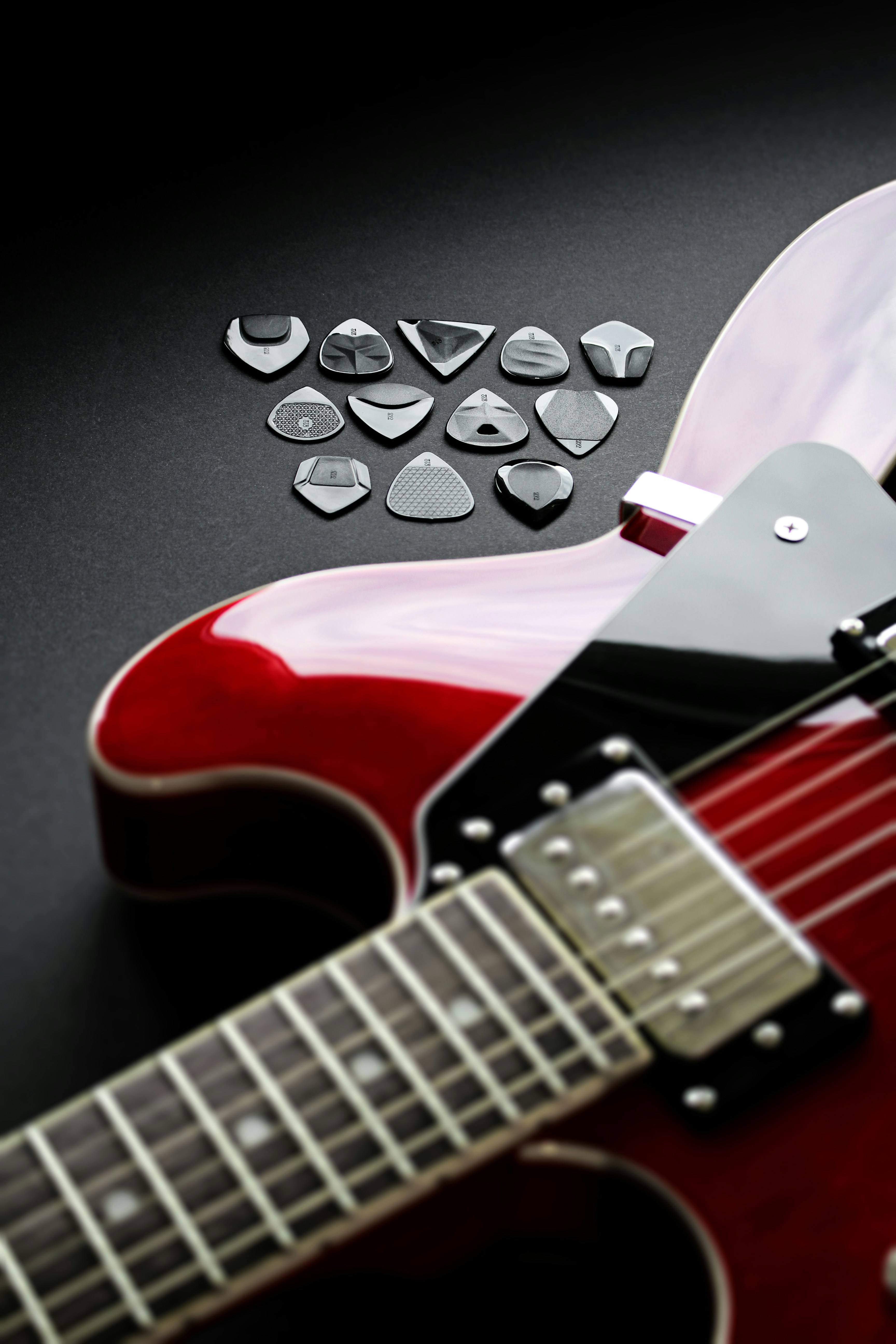 A close up of a red guitar with a guitar picker photo – Free Electric ...