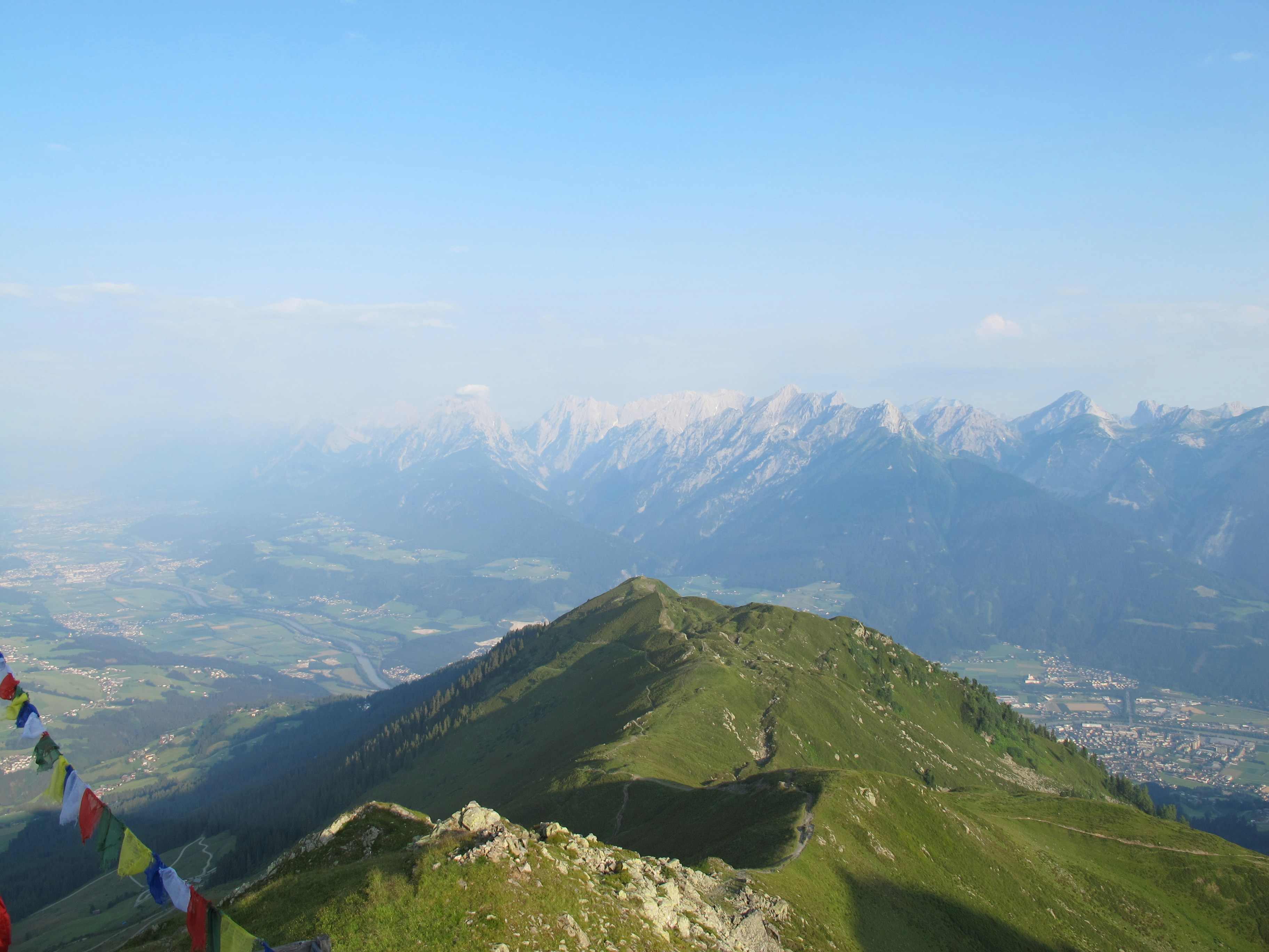 Expansive mountain ridge with rugged peaks under a clear blue sky.