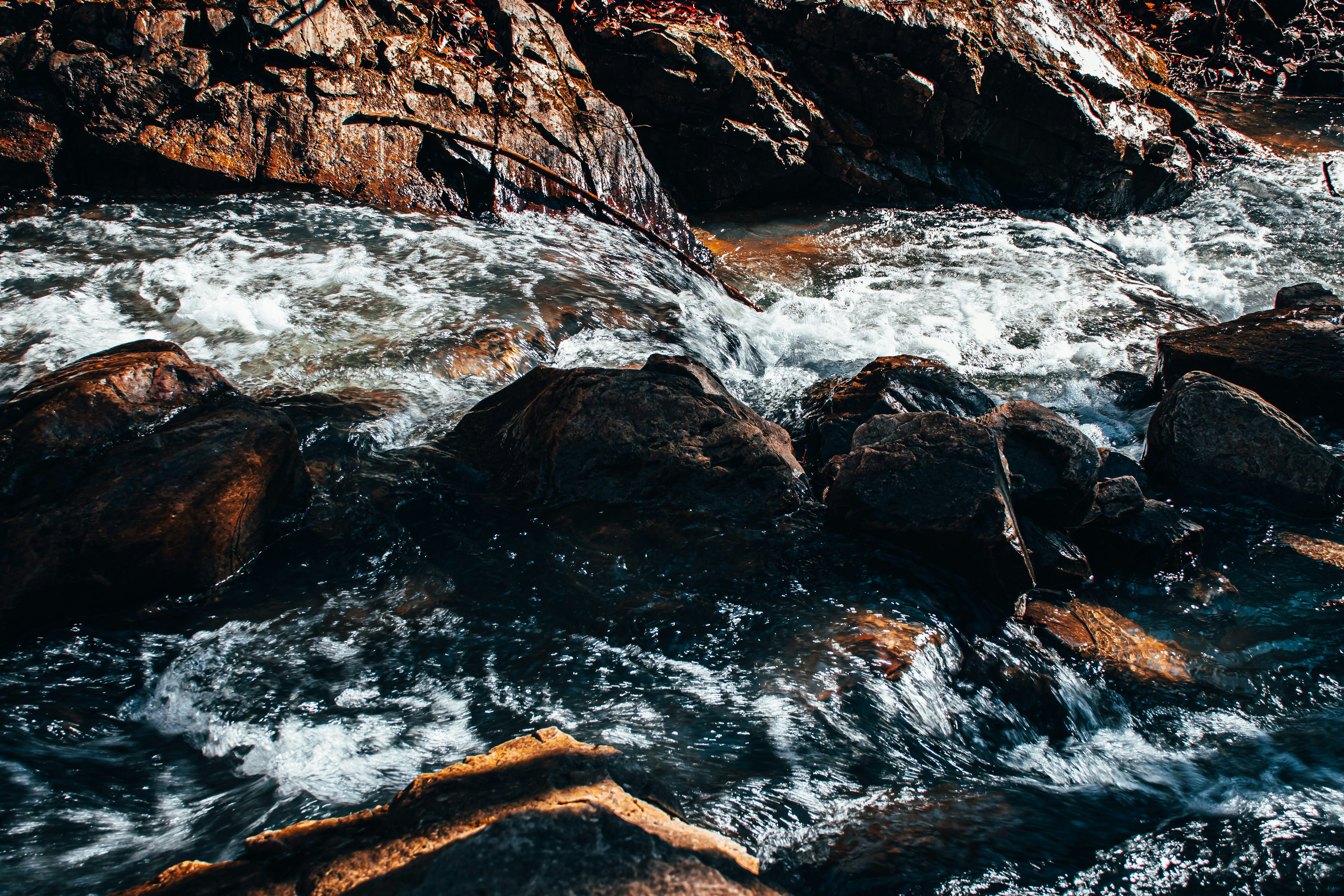 The water is rushing over the rocks in the river photo – Free Rock ...