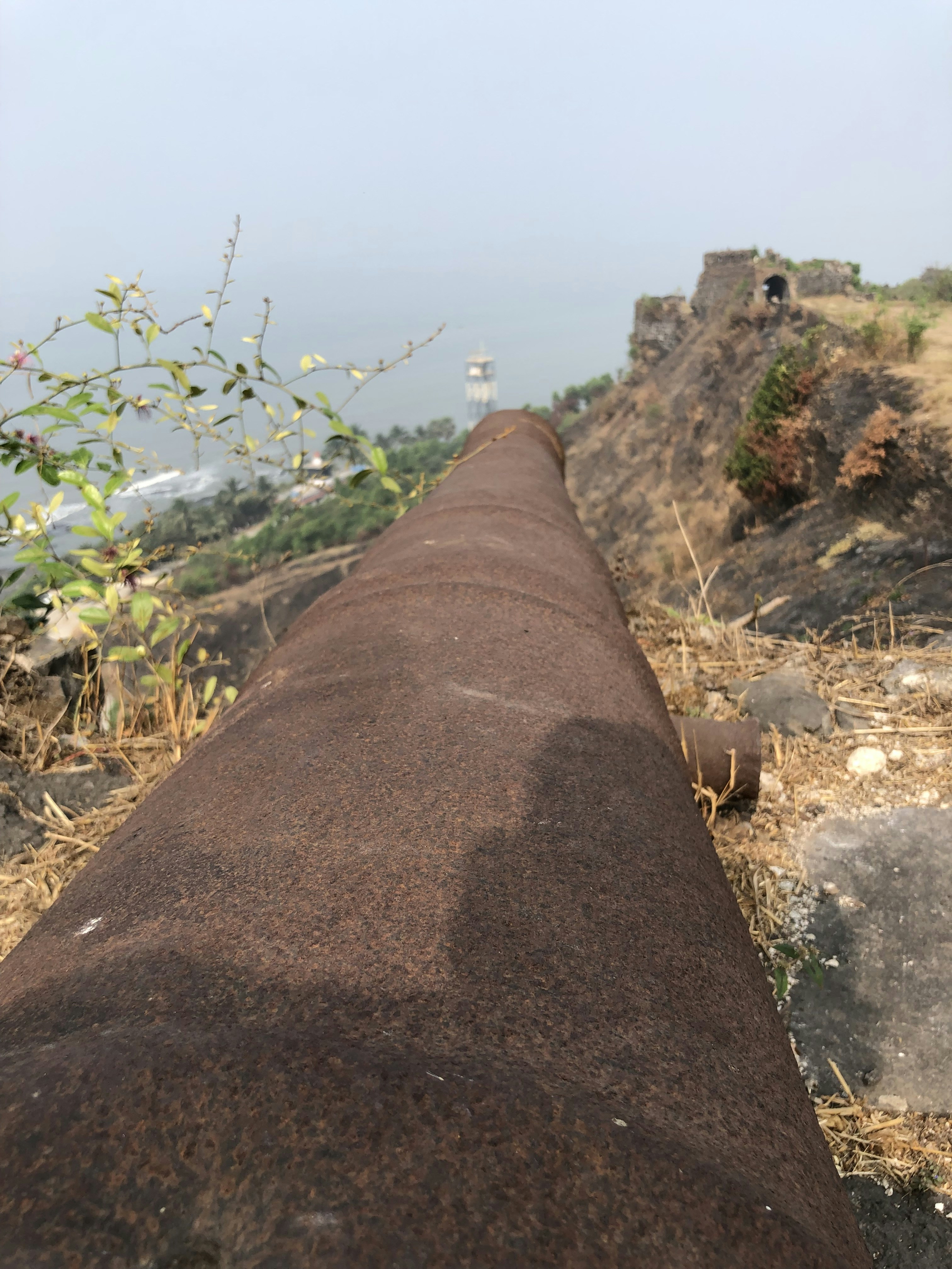 A very long pipe sitting on the side of a hill photo – Free Korlai ...