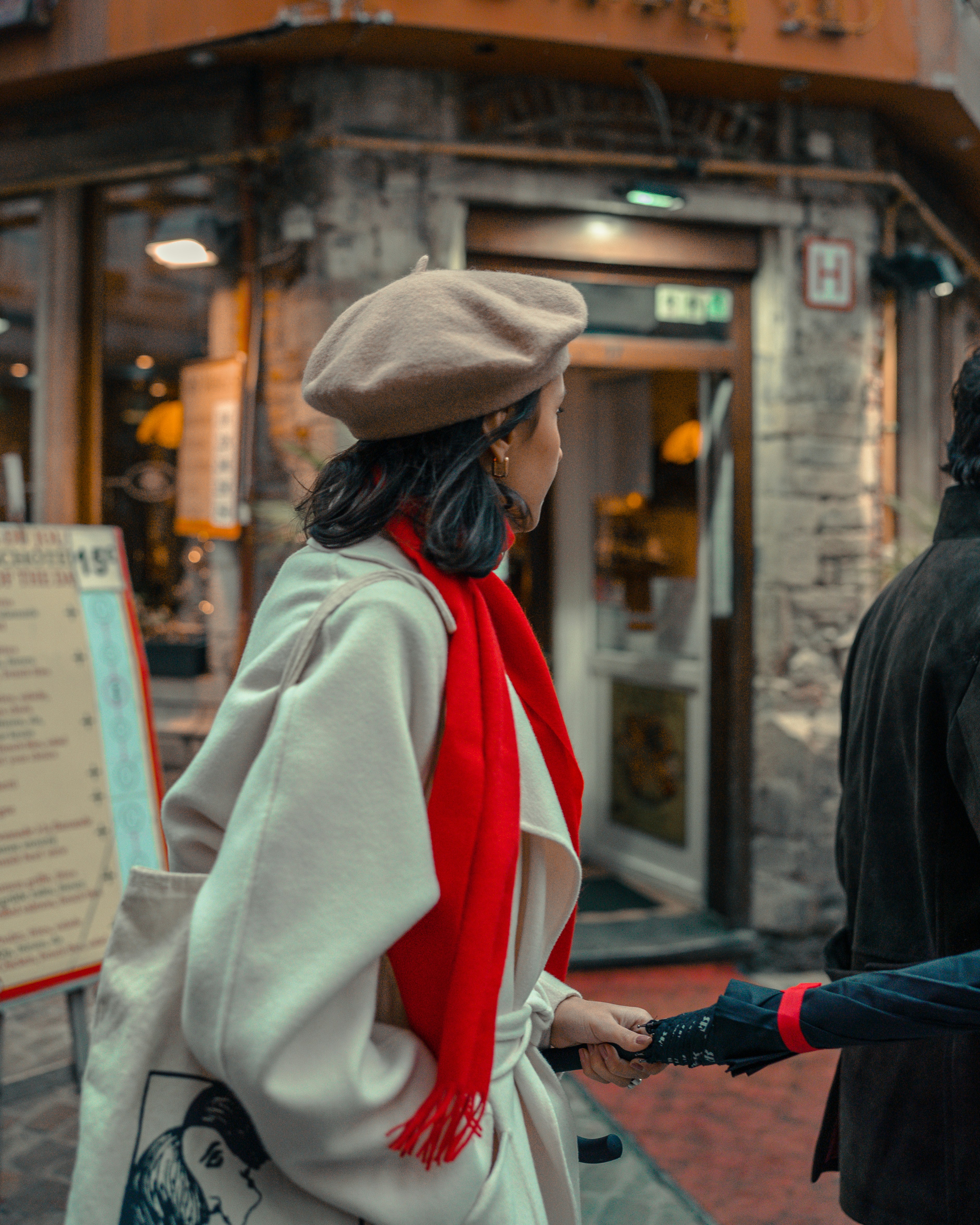 Red Scarf Rendezvous on a Cobblestone Street