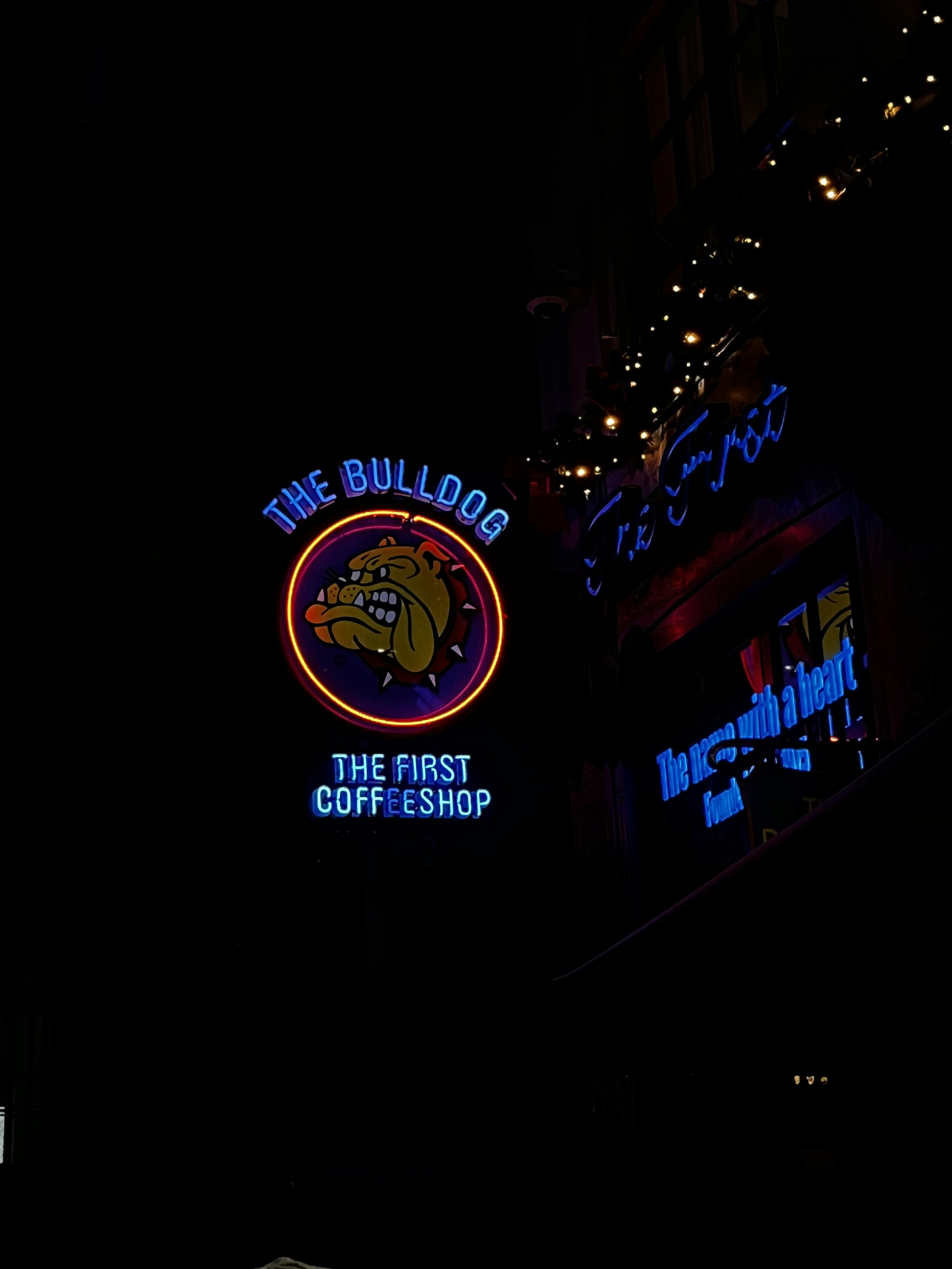 a building with a neon sign on the side of it