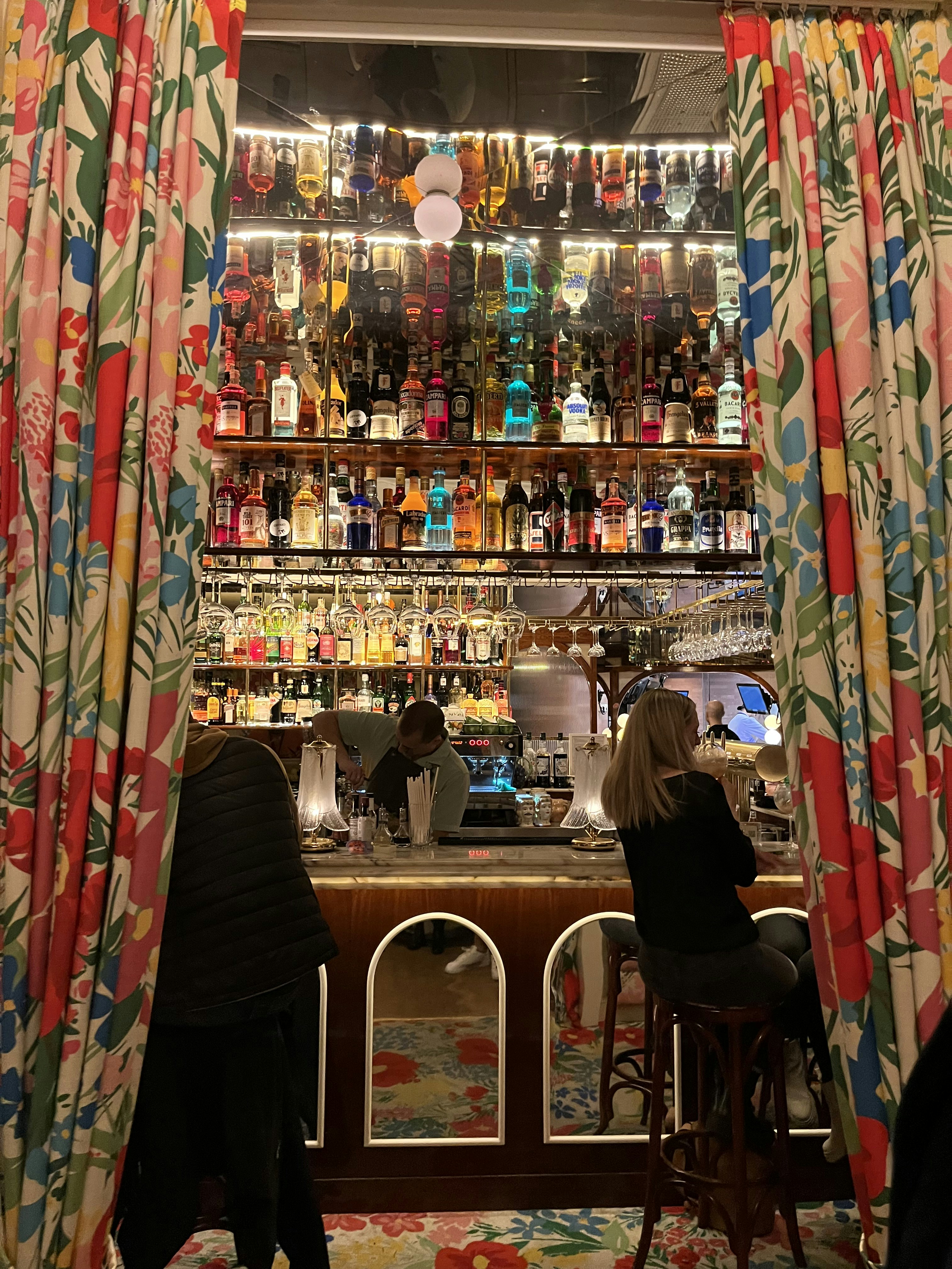 Curtain-Frame Liquor Bar: A Multicolor Nighttime Palette