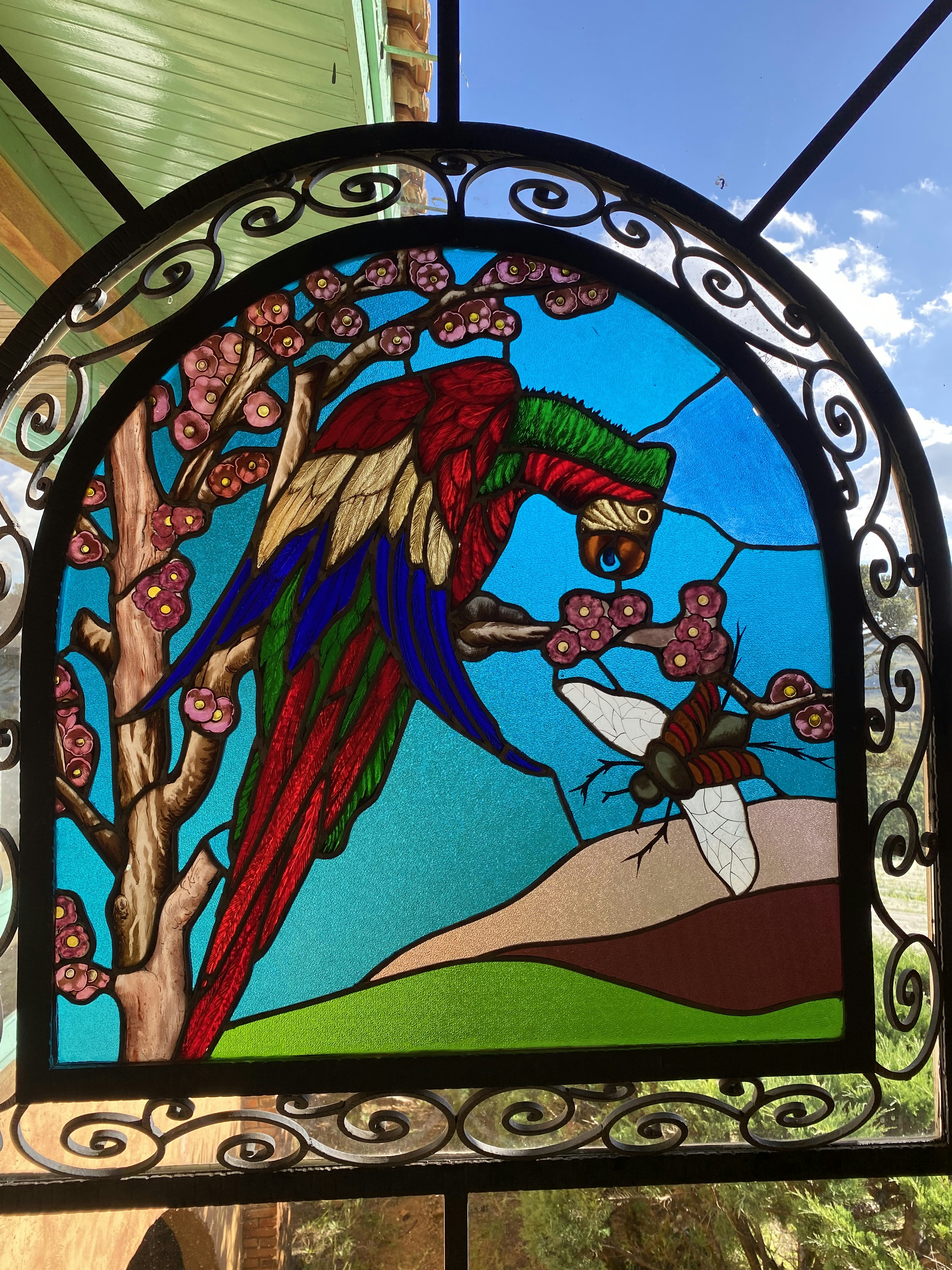 a stained glass window with a bird on it