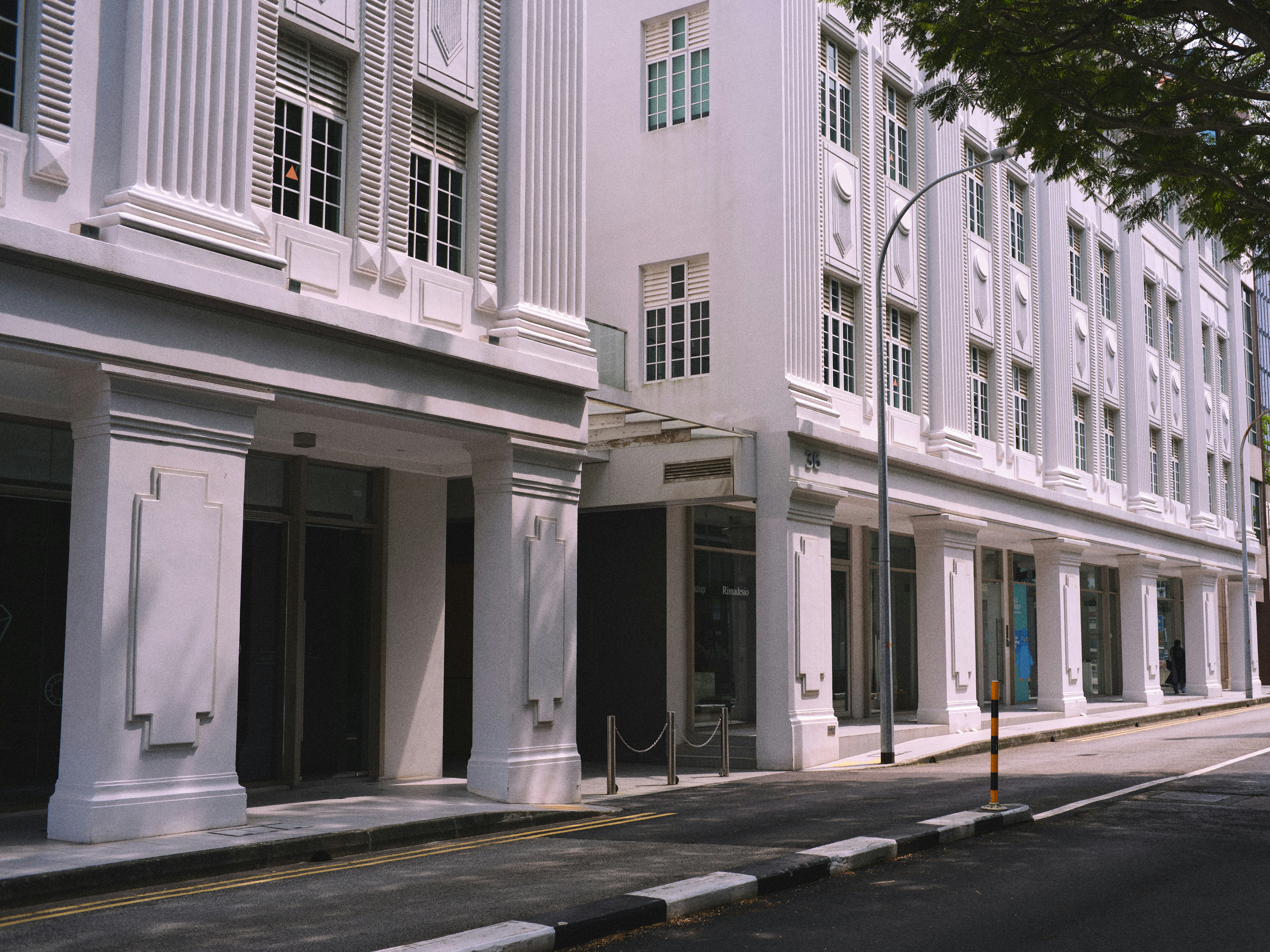 A row of white buildings on a city street photo – Free City Image on ...
