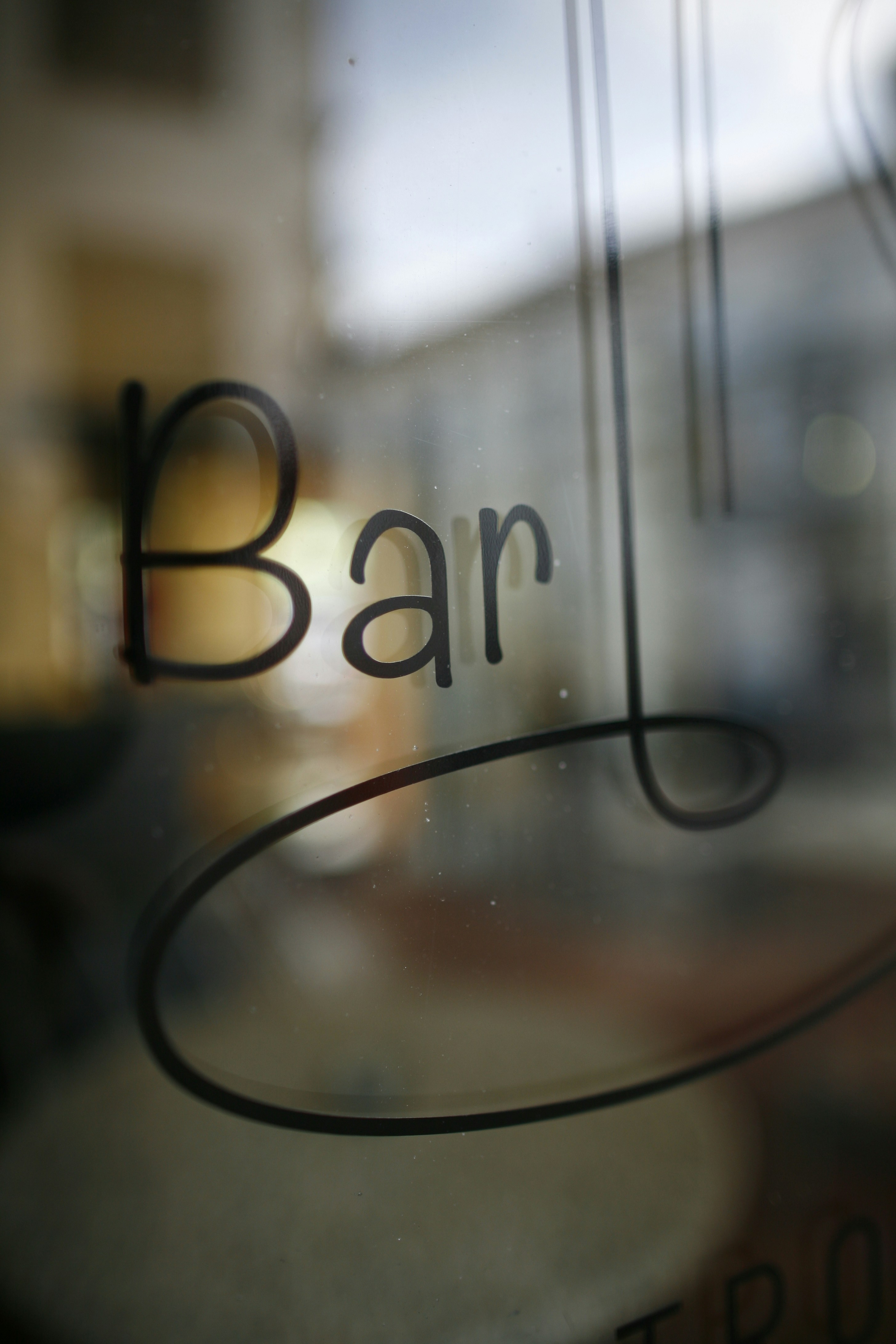 Bar Sign in Soft Focus: Letters Framed by Window Glass