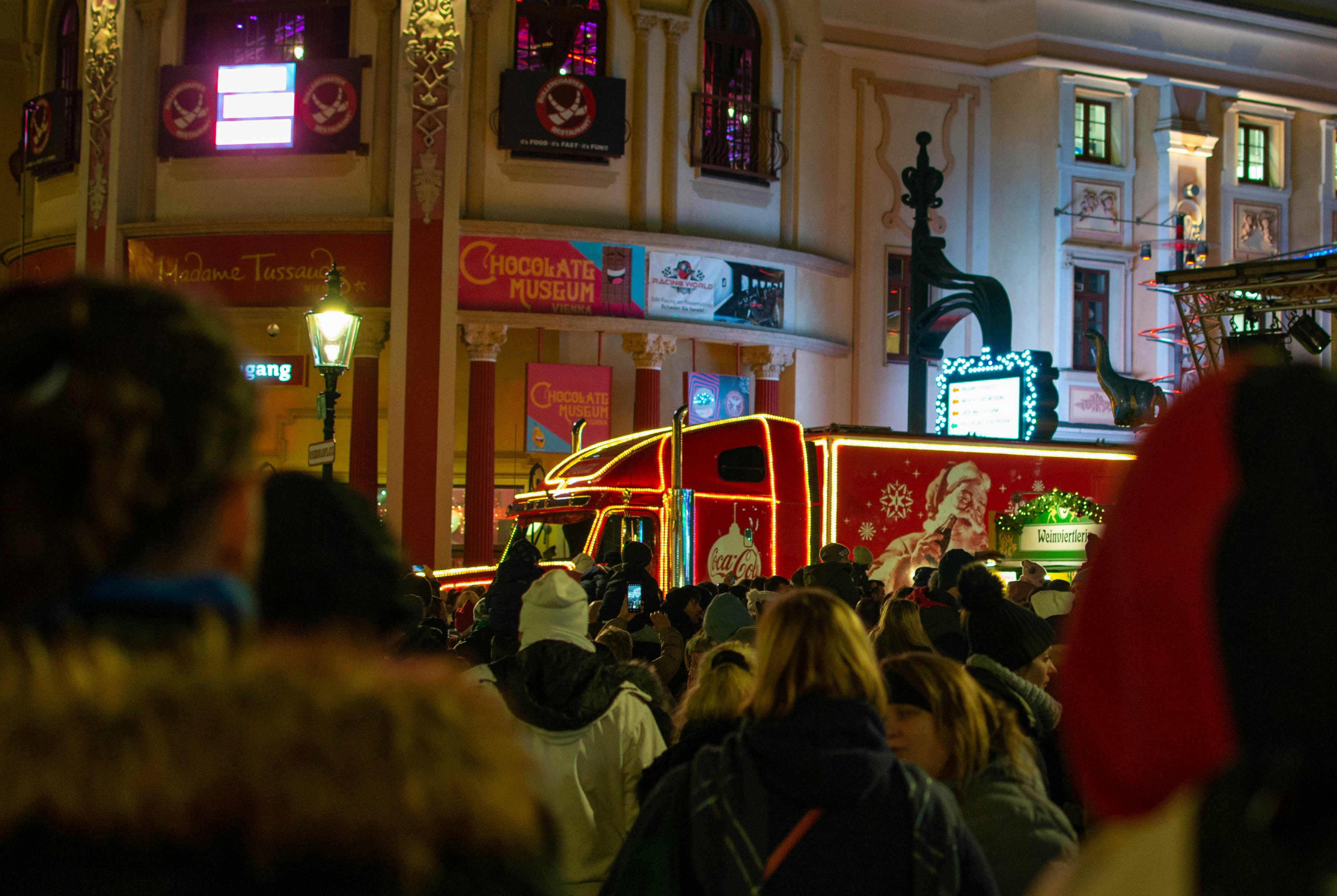 Crimson Vintage Bus Anchors a Winter Night Parade