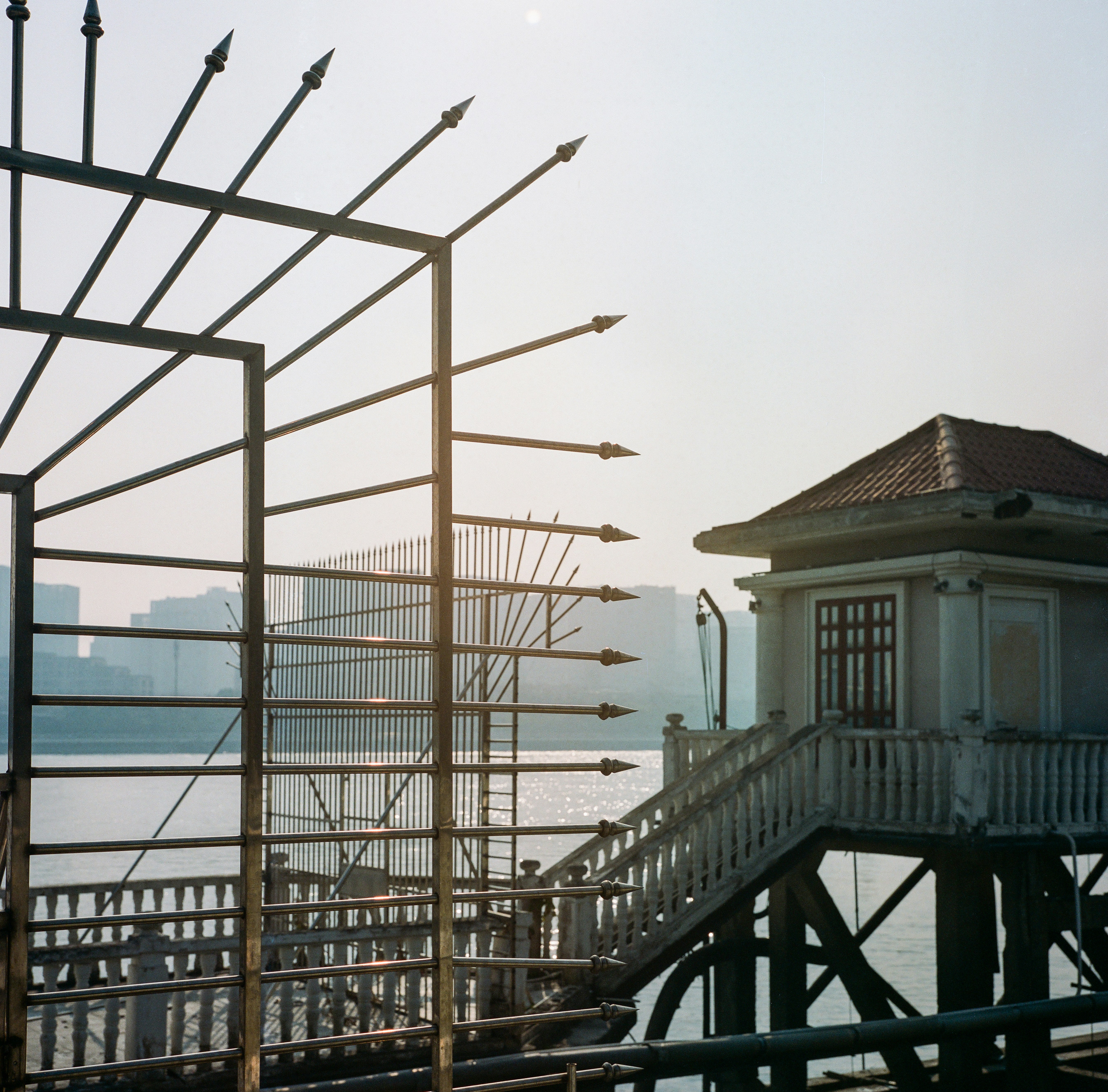 A building sitting on top of a pier next to a body of water photo ...