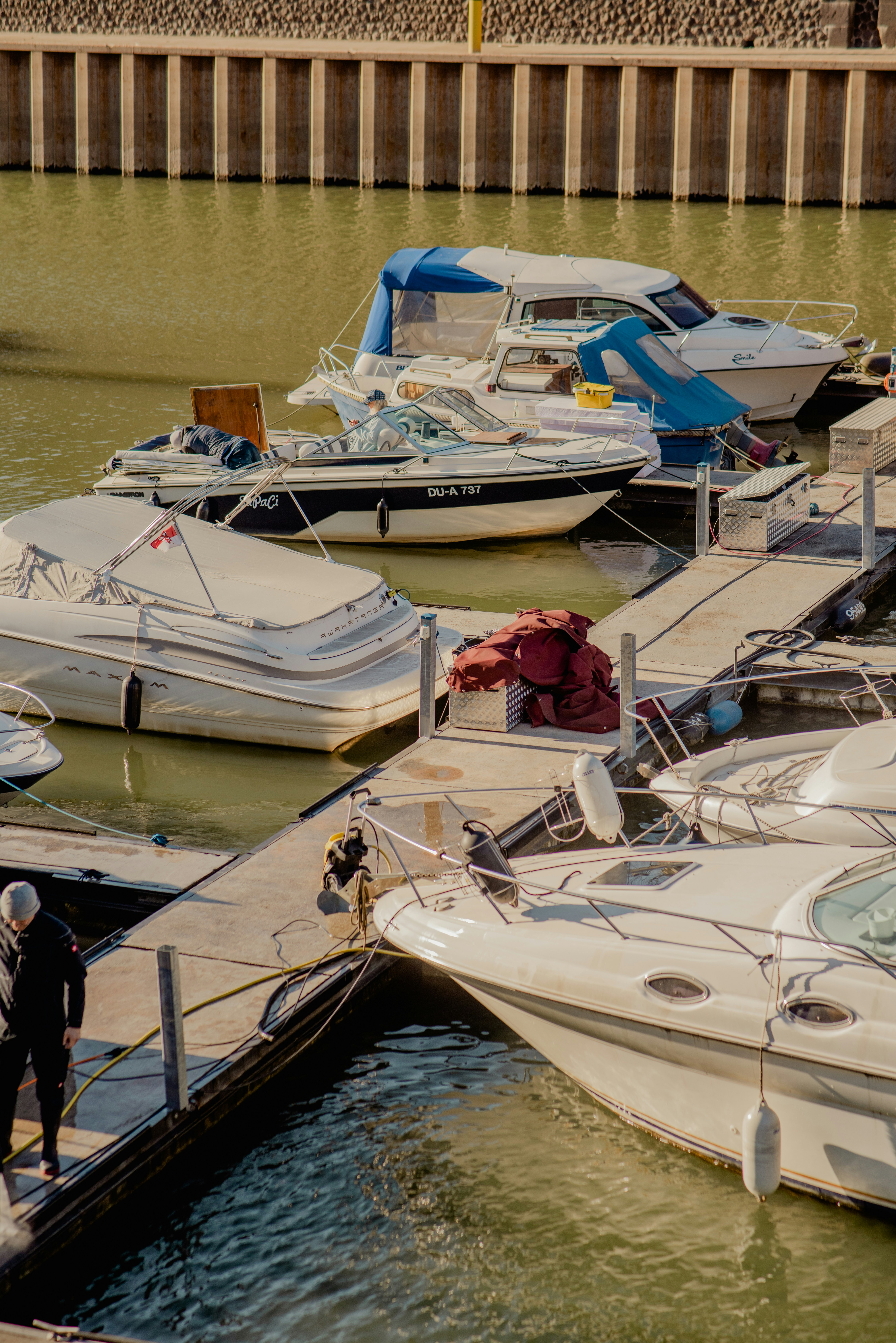 Blue Canopy Cruiser Anchored in a Quiet Marina